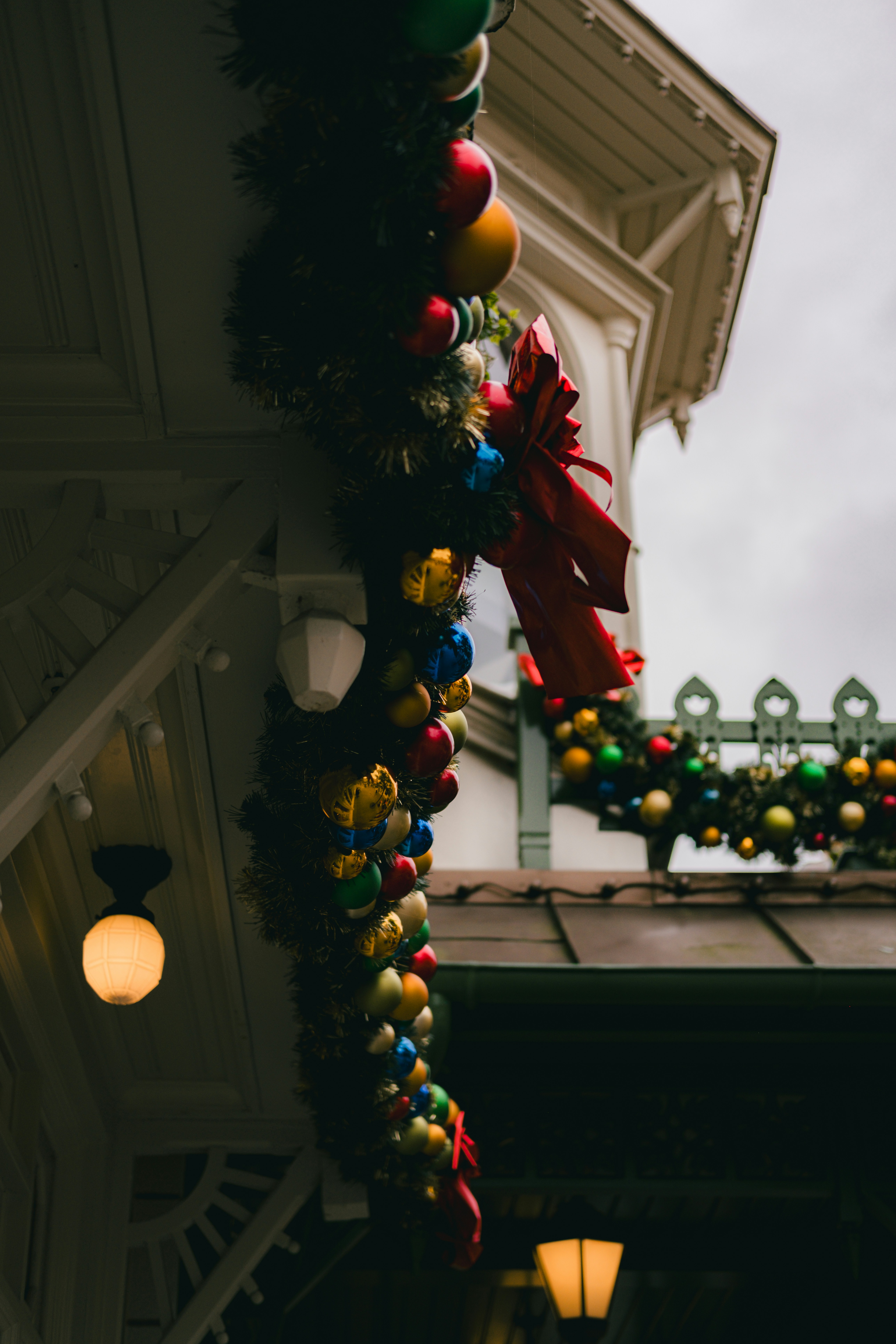 A christmas wreath hanging from the side of a building