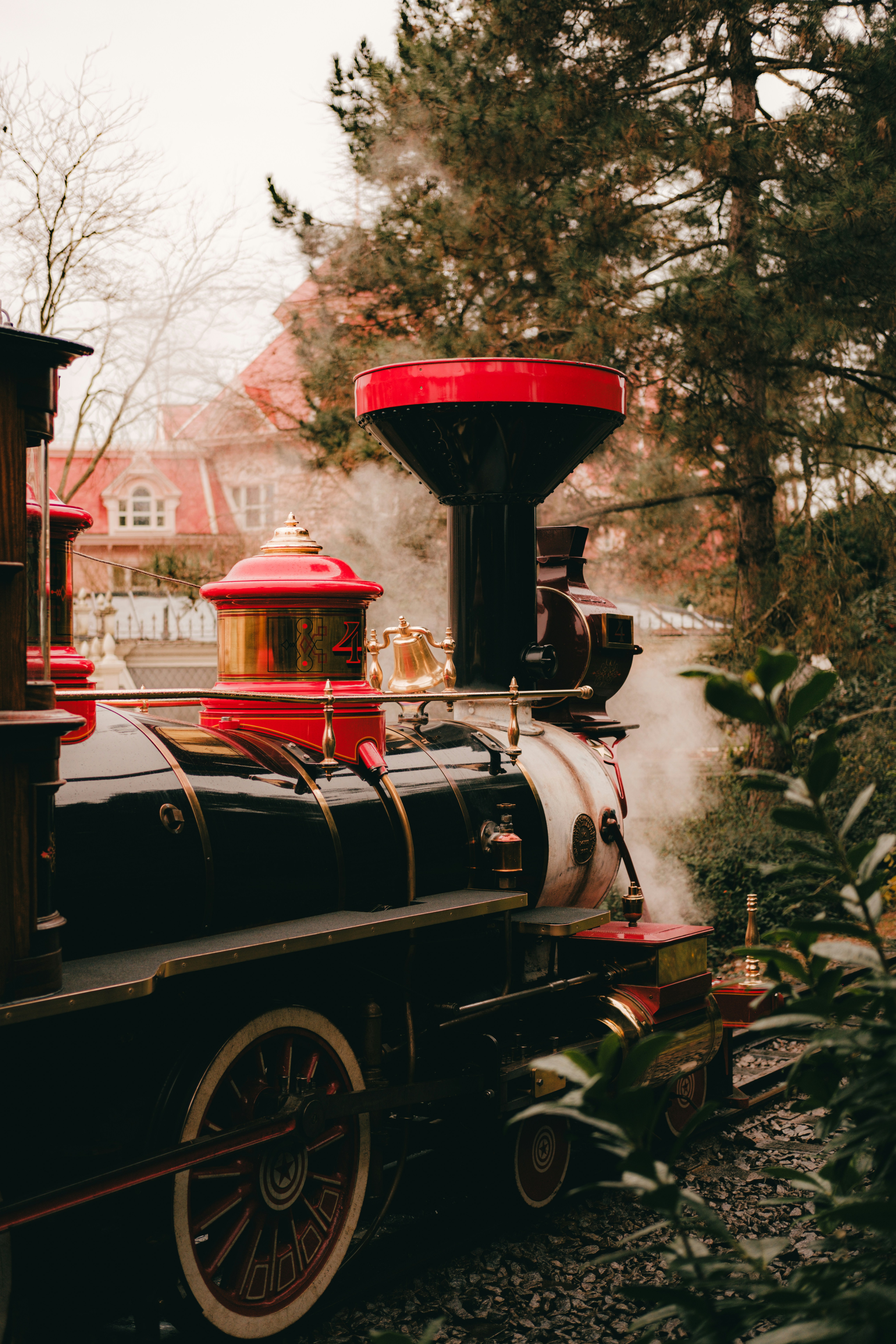 Crimson Funnel in Quiet Garden: A Vintage Steam Engine