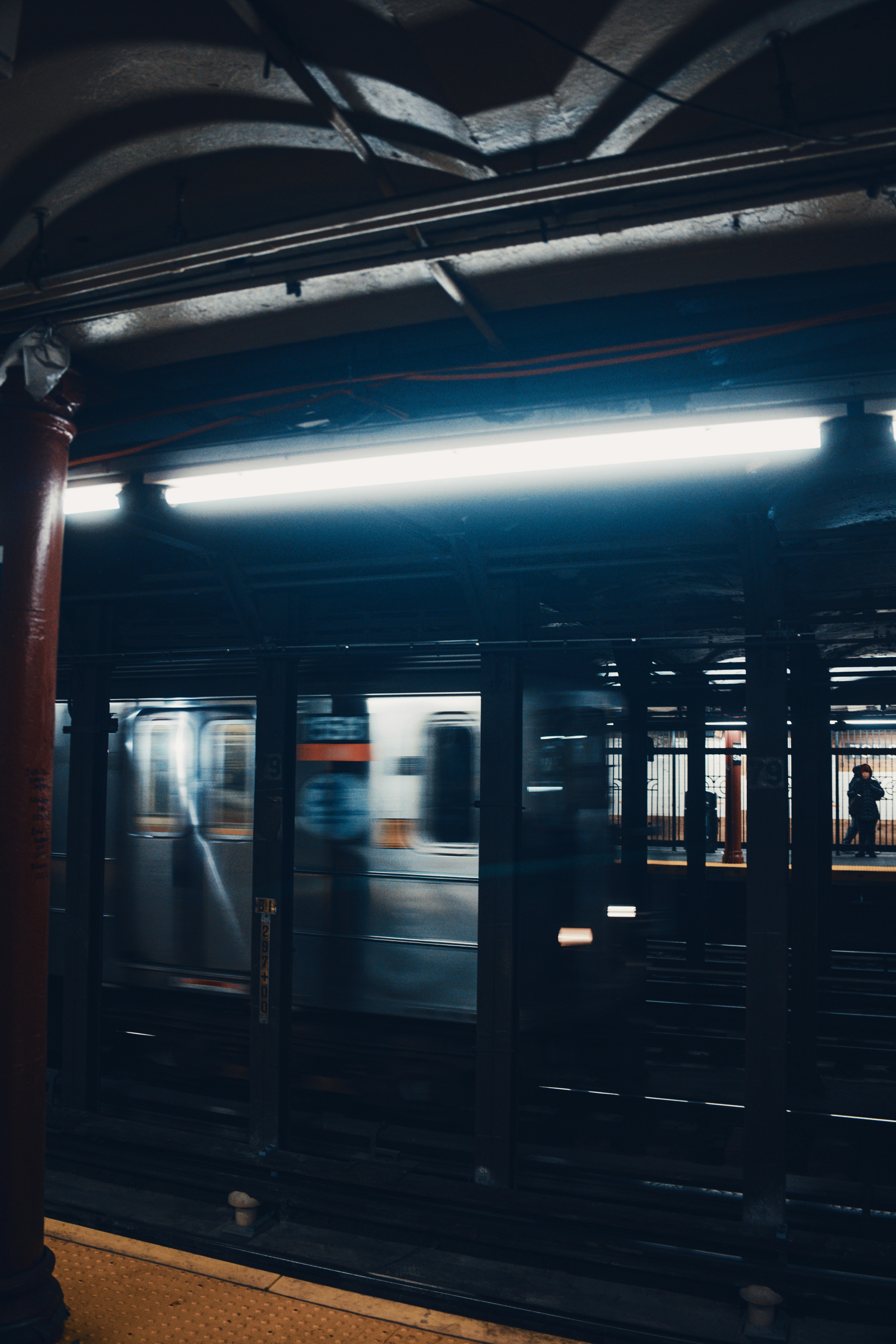 A subway train at a train station at night photo – Free Building Image ...