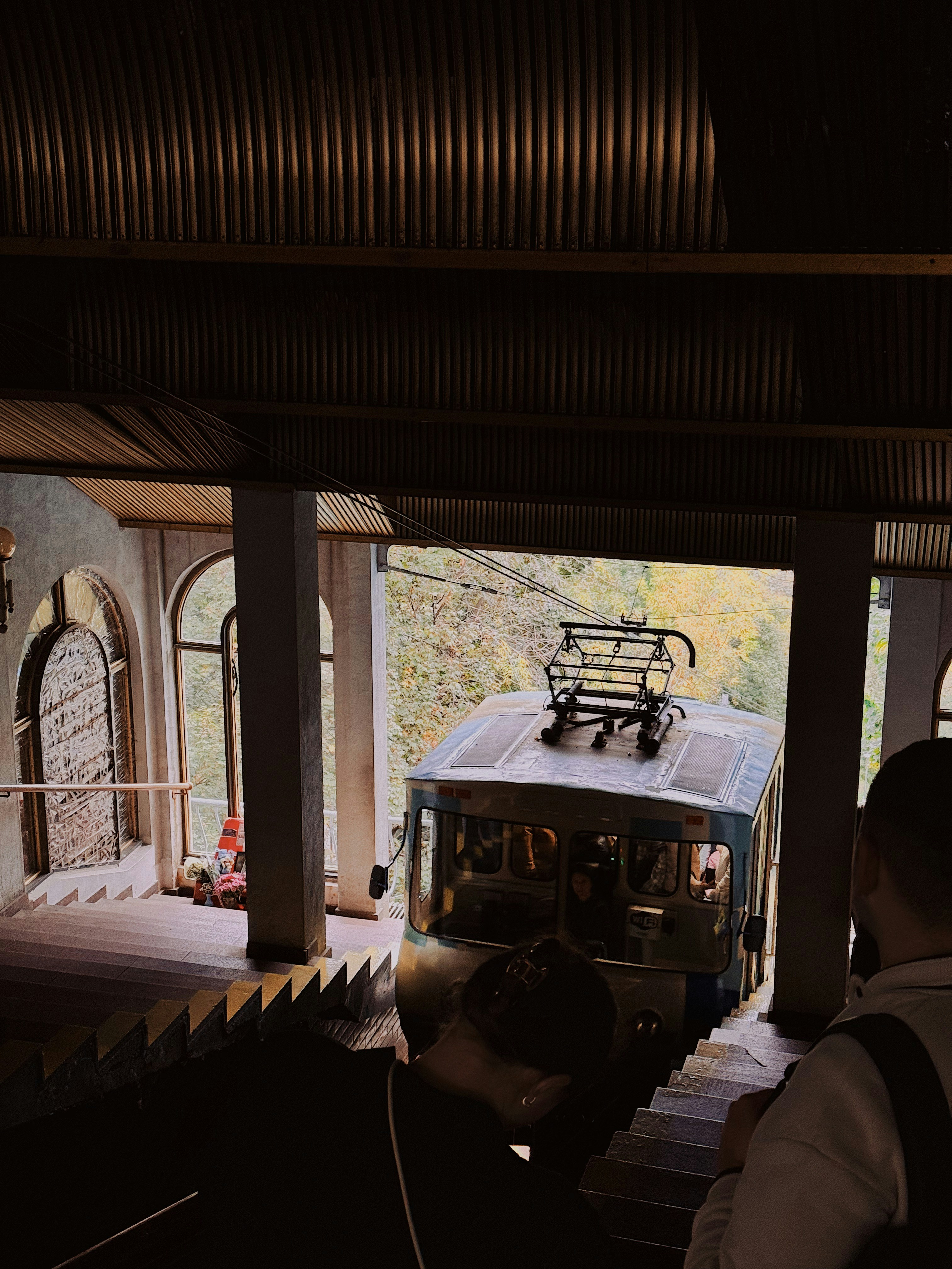 A man standing next to a train in a train station photo – Free Man ...