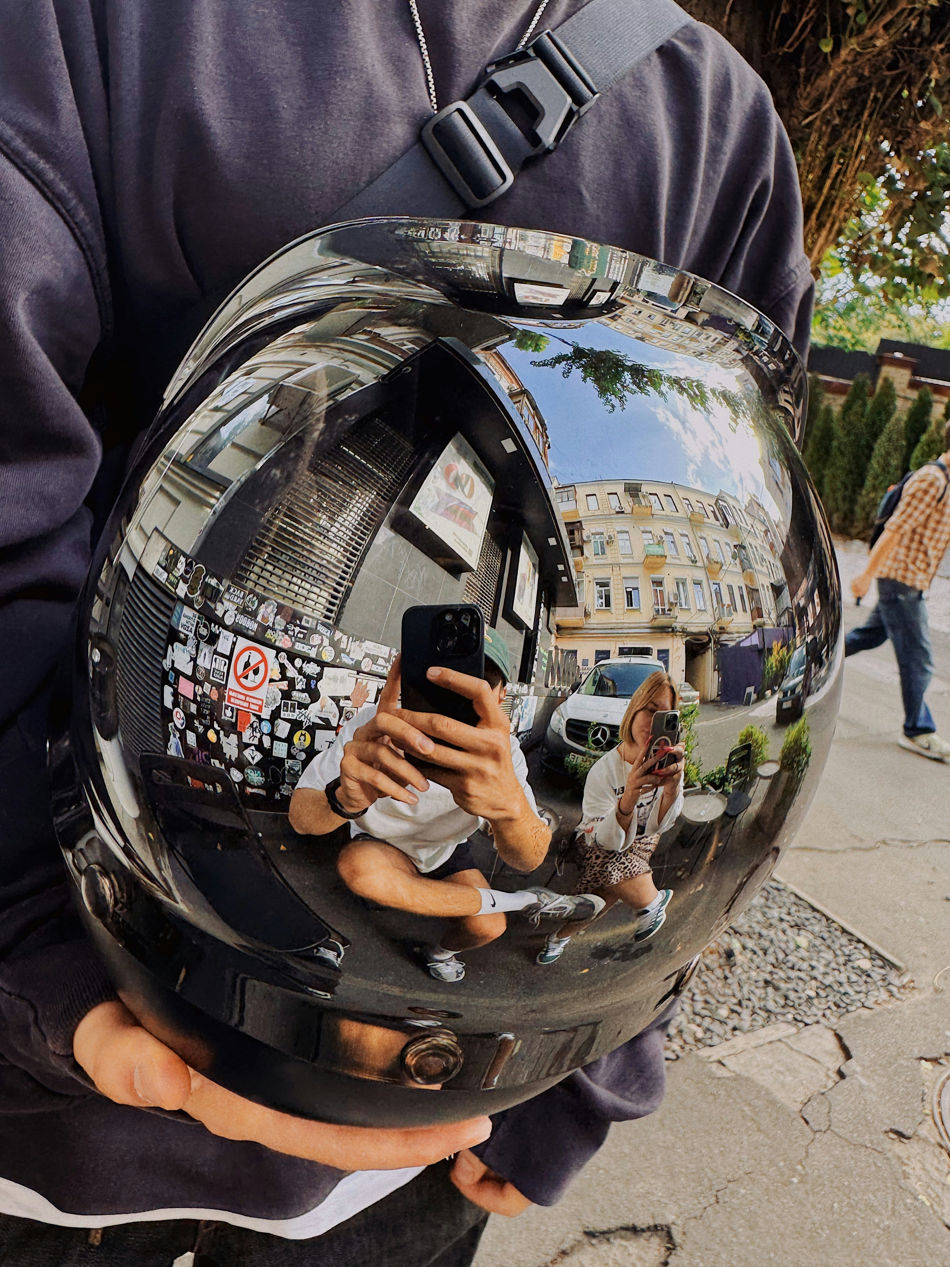 A person wearing a helmet holding a cell phone photo – Free Woman Image ...