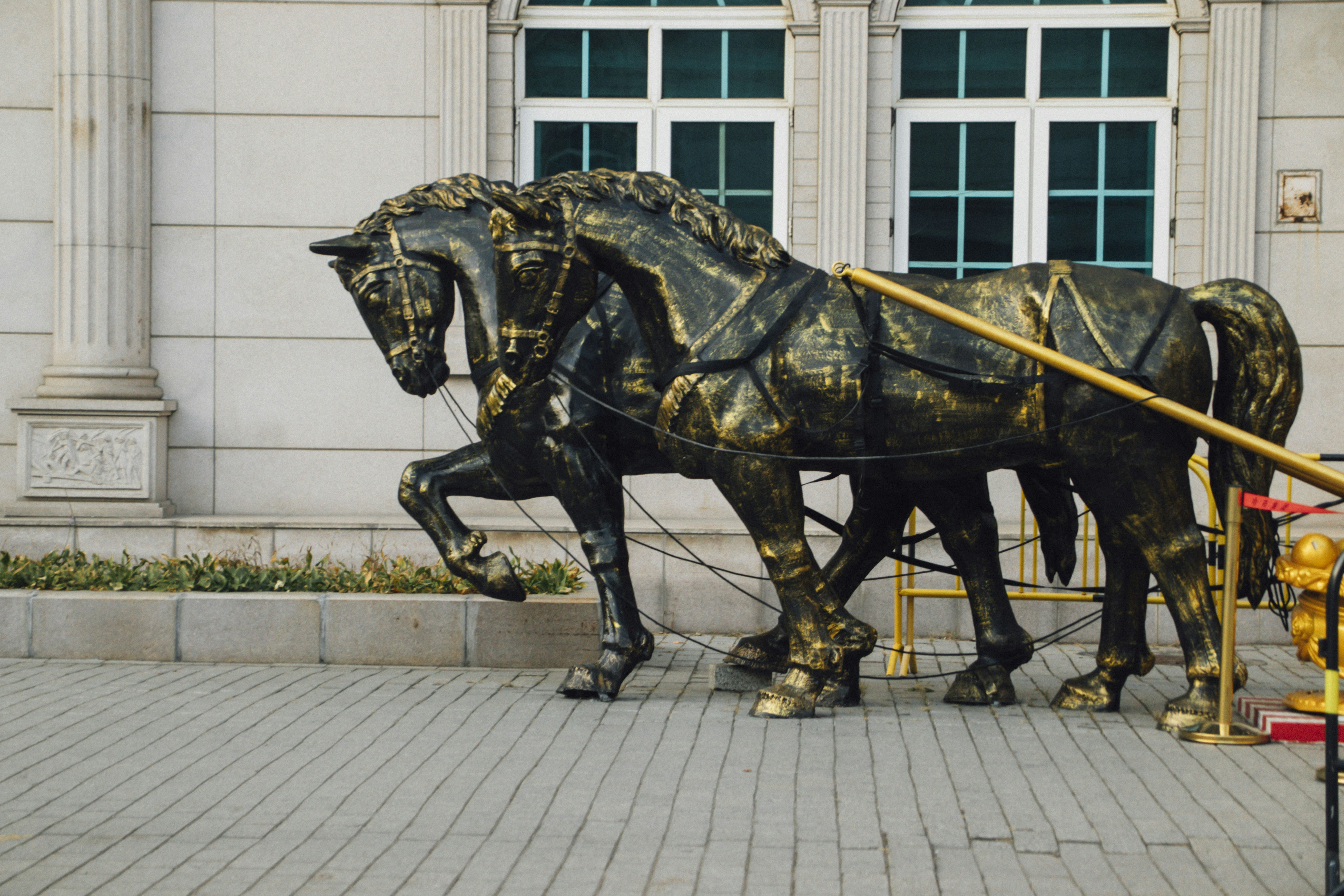 Triple Bronze Steeds Stand Guard Before a Neoclassical Facade
