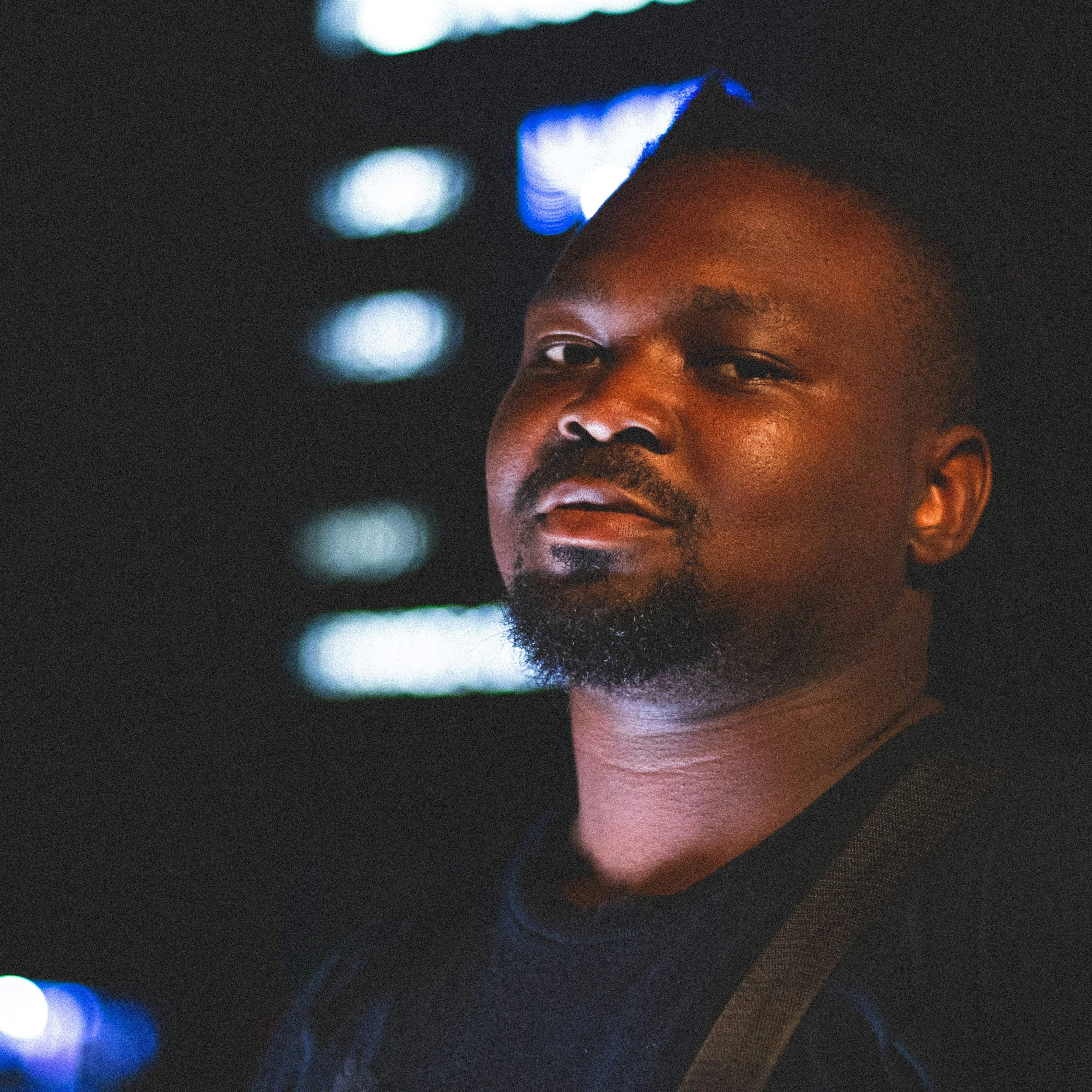 A man standing in front of a building at night photo – Free Musuku ...