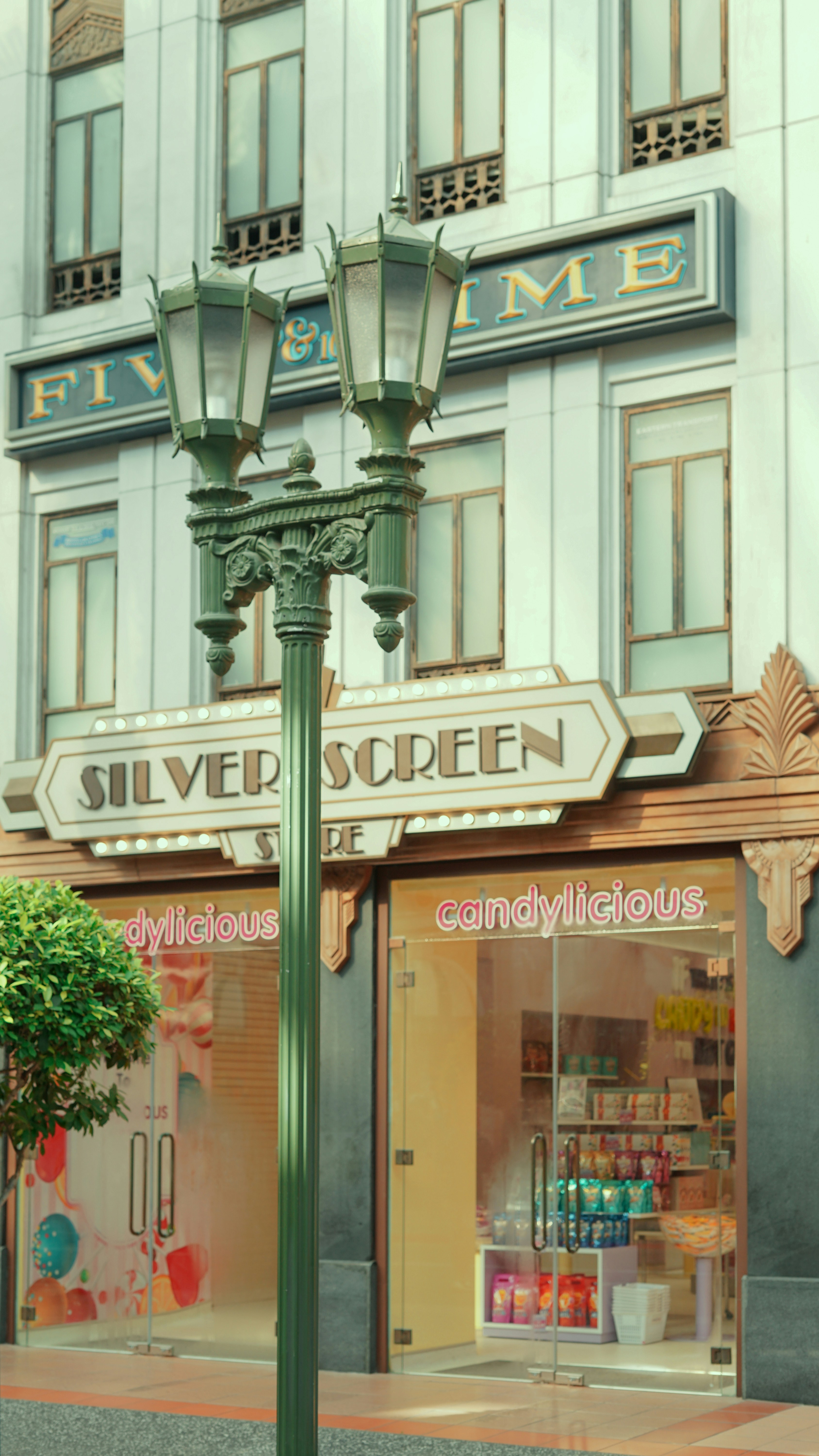 Ornate Streetlamp Framing a Pastel Storefront