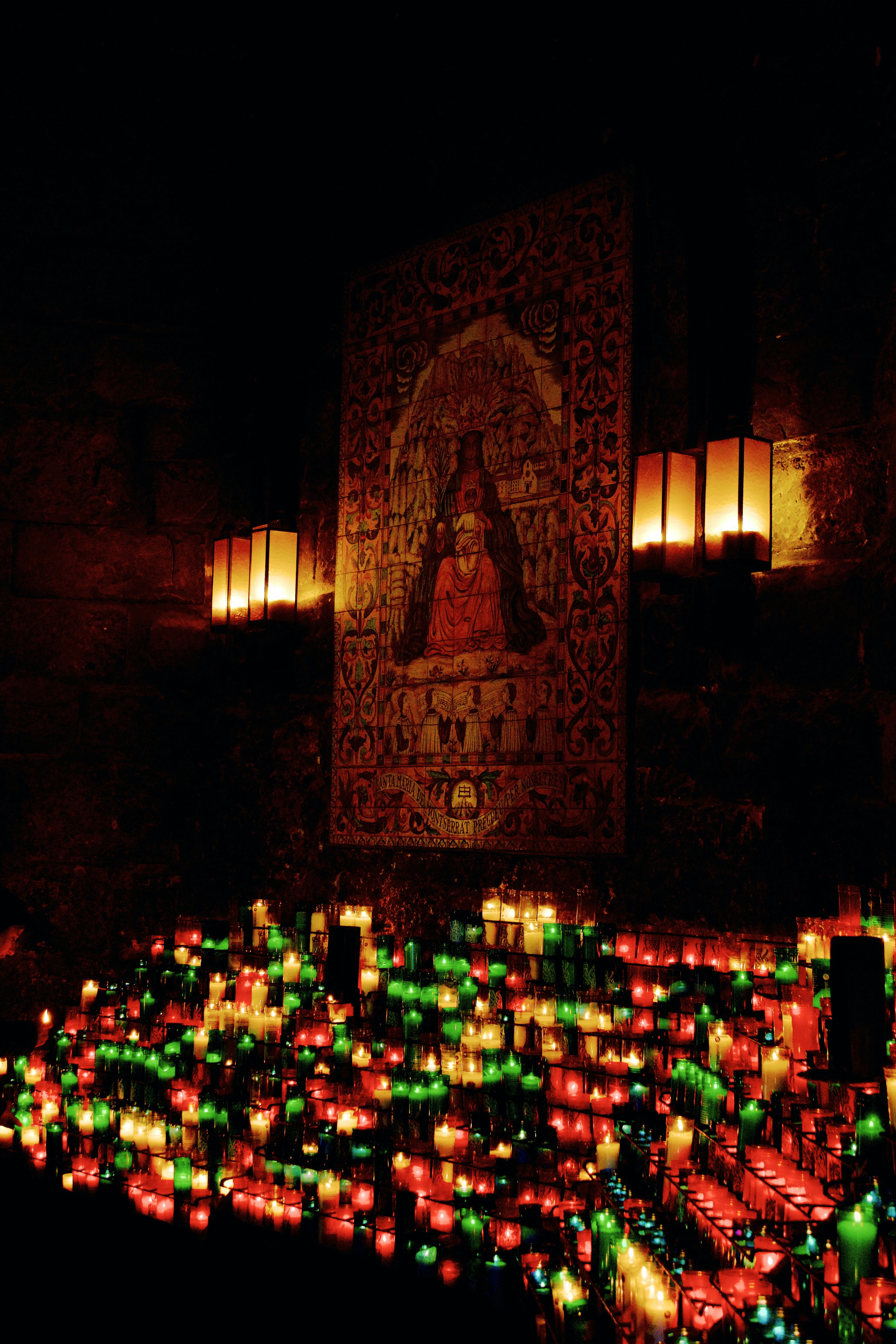 Candlelit Shrine Portrait: Central Painting Surrounded by a Sea of Colored Lights