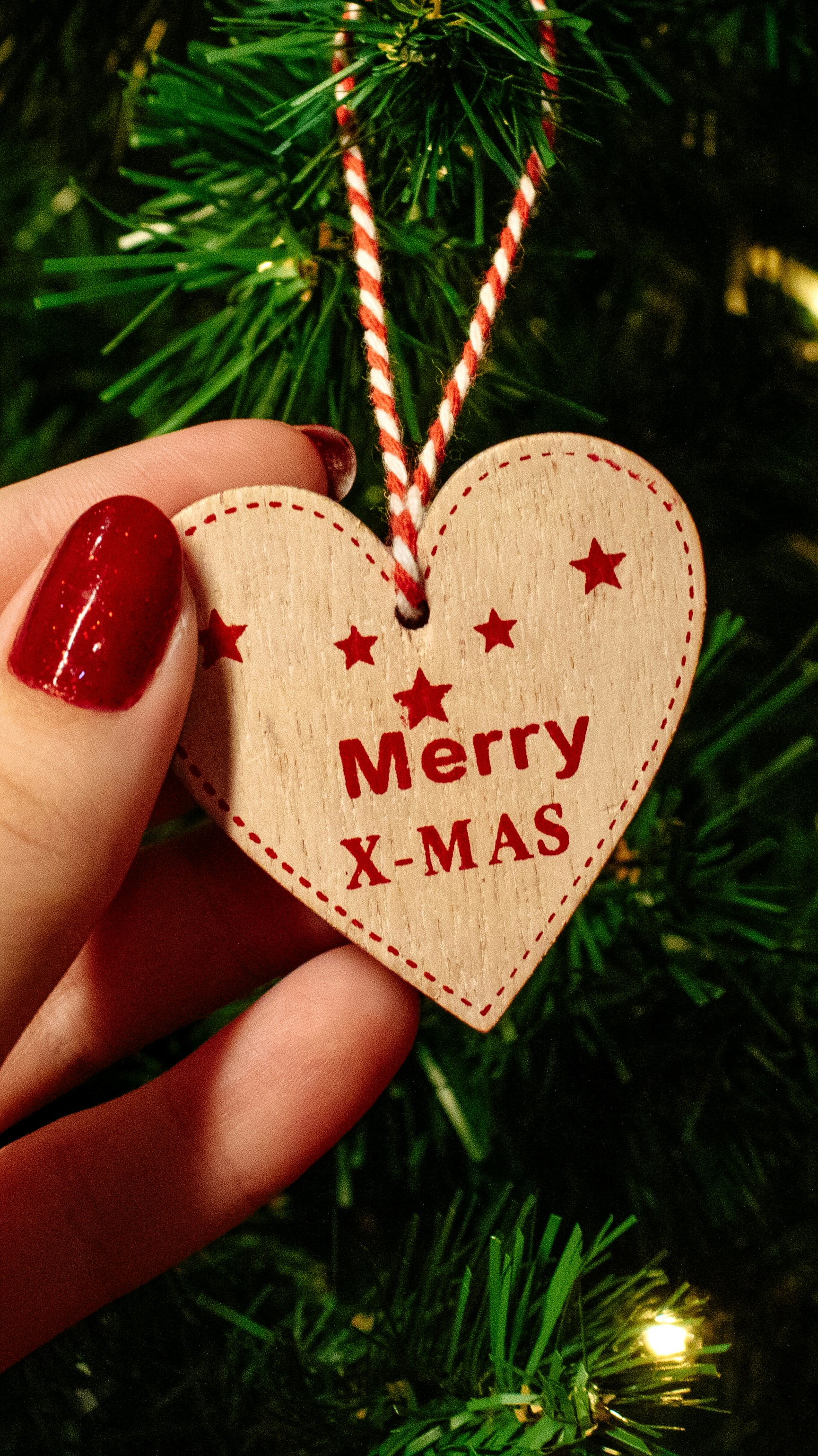 Whisper of Christmas: A Wooden Heart Ornament on a Pine-Needle Backdrop