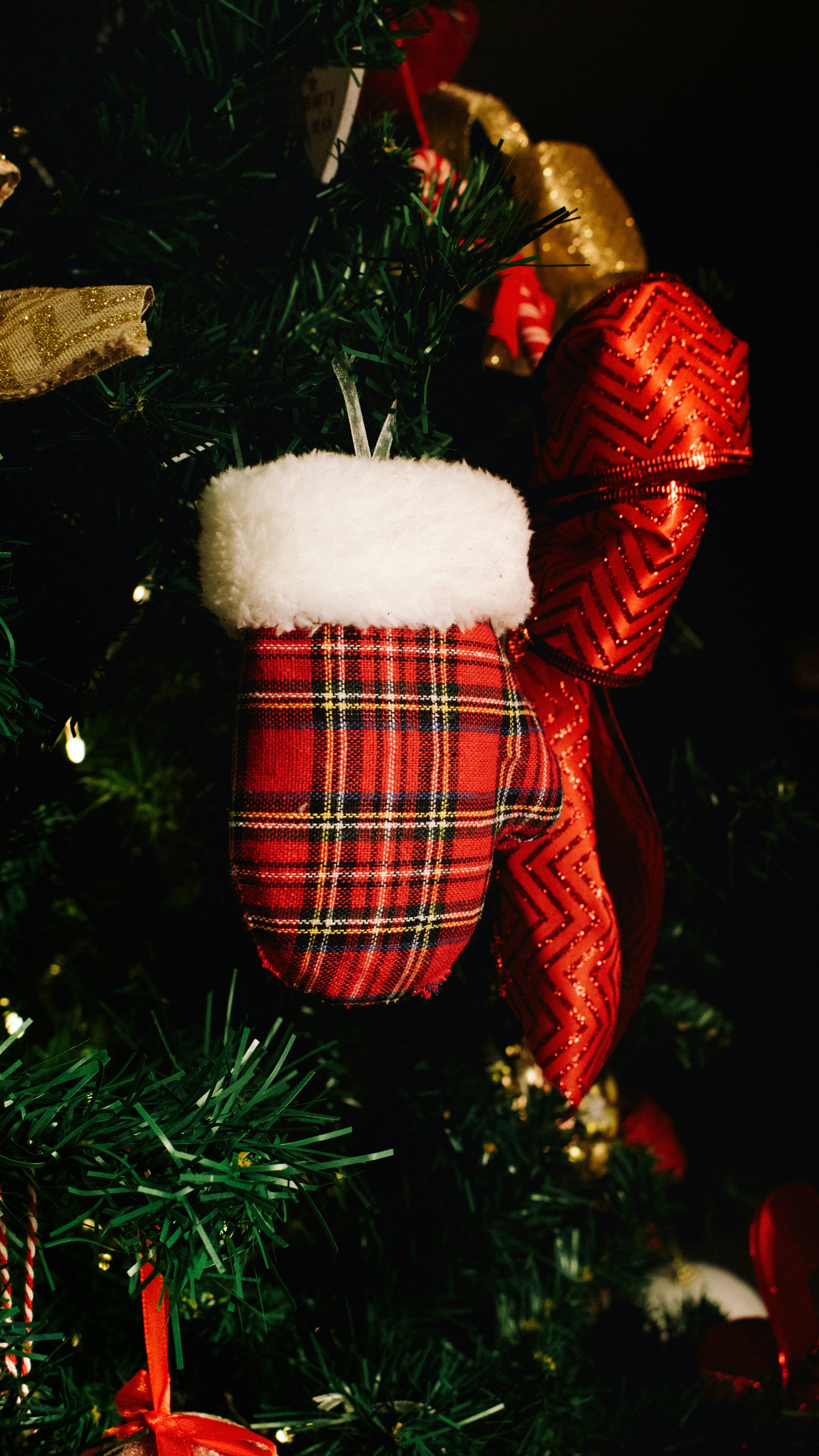 Cozy Plaid Mitten on a Christmas Tree Amid Soft Glow