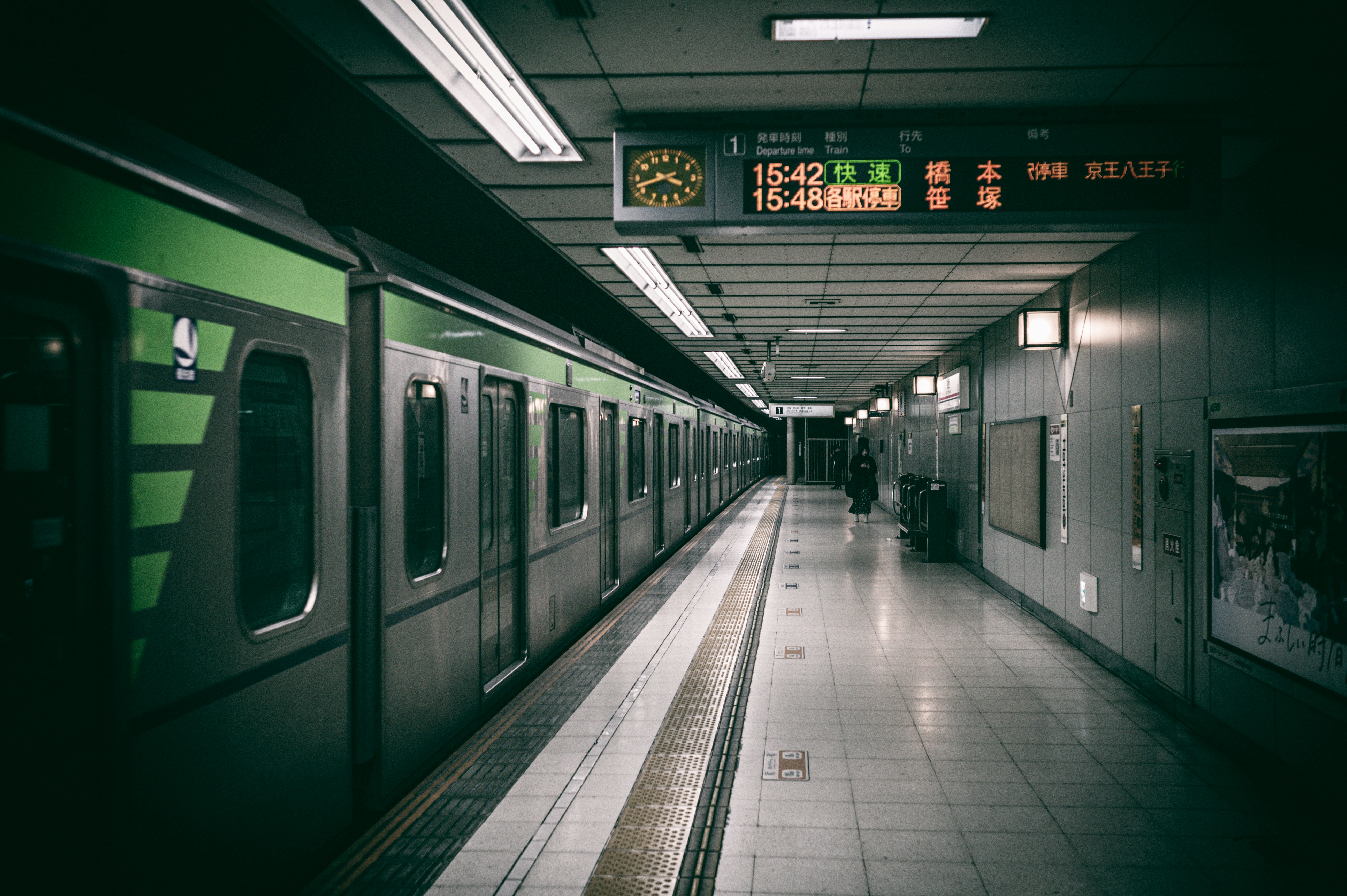 A subway station with a green and white train photo – Free Street ...