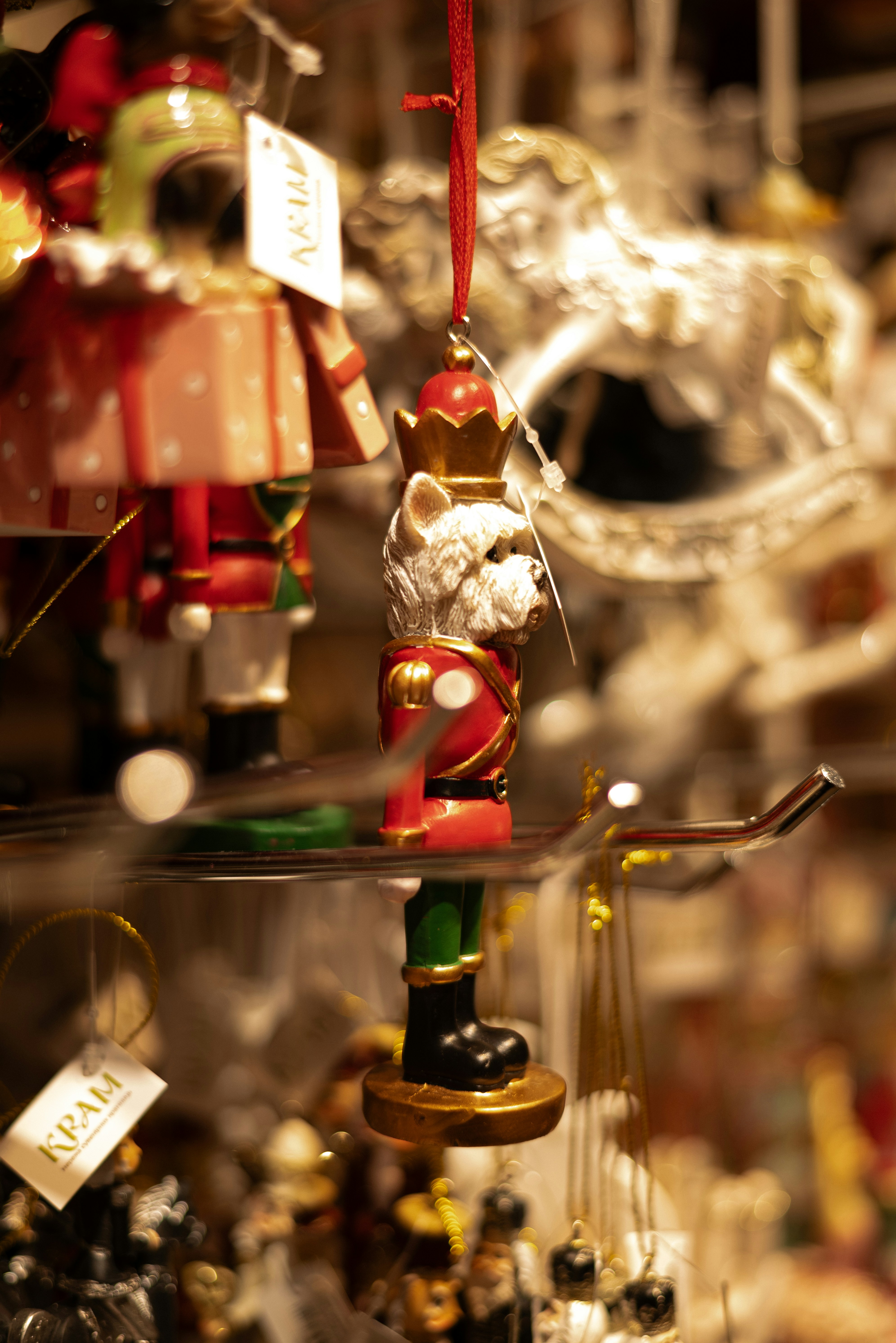 Crimson Nutcracker Ornament Hovering in a Sea of Soft Holiday Bokeh