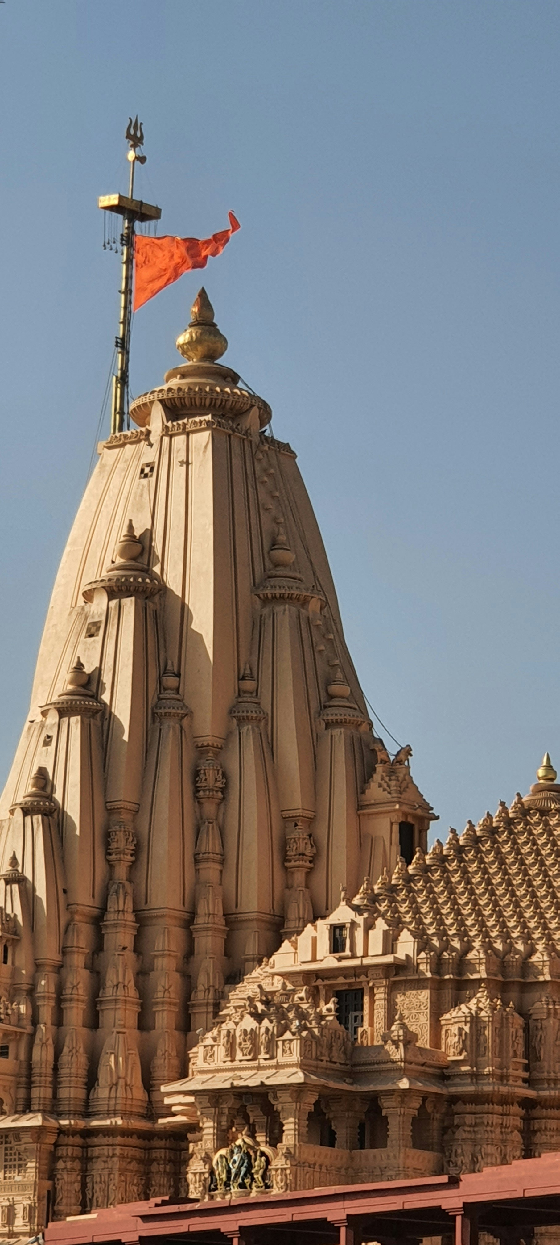 A tall building with a cross on top of it