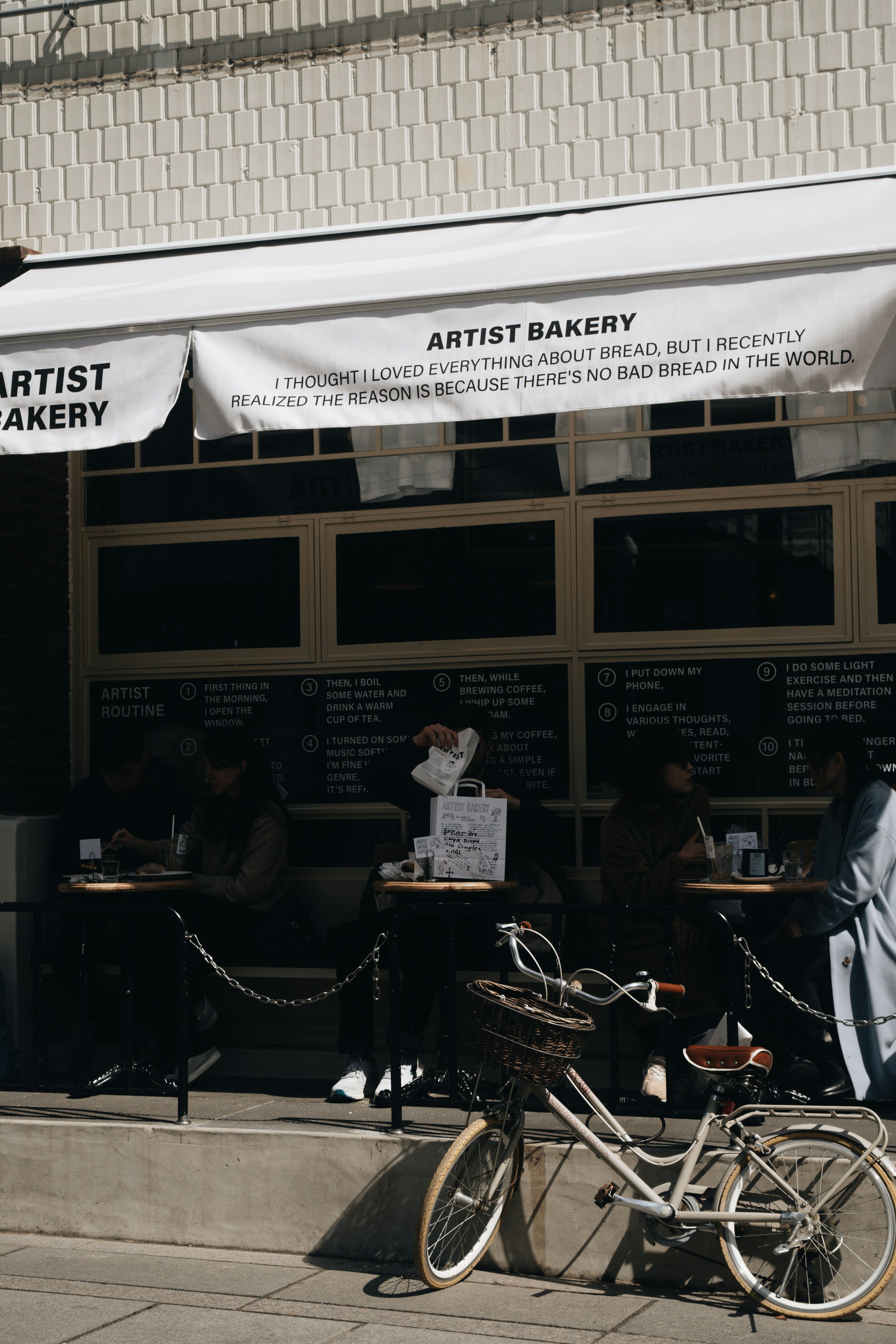 ARTIST BAKERY Banner, Bicycle, and Quiet Street Scene
