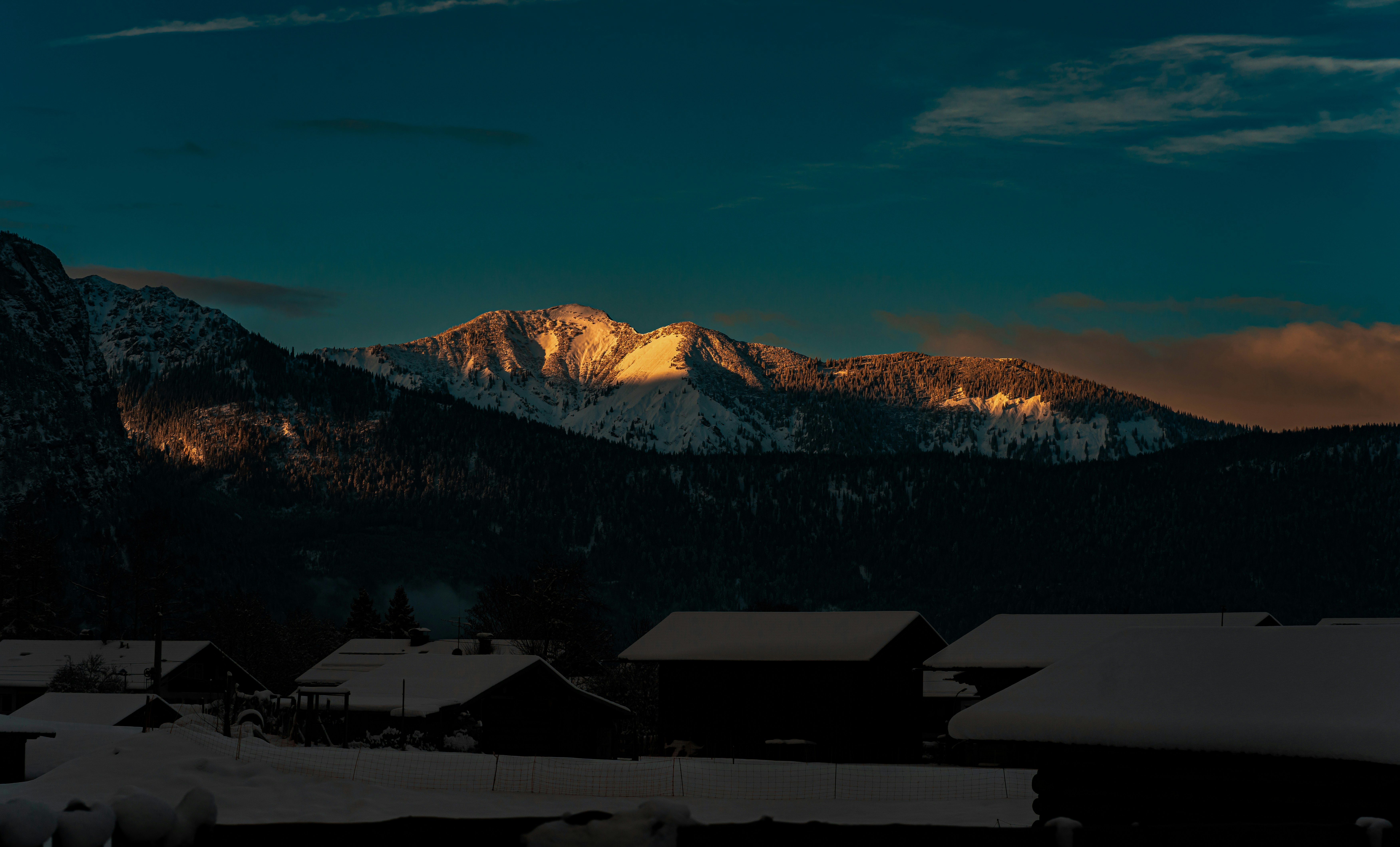 Crest Dawn over a Snowbound Alpine Village