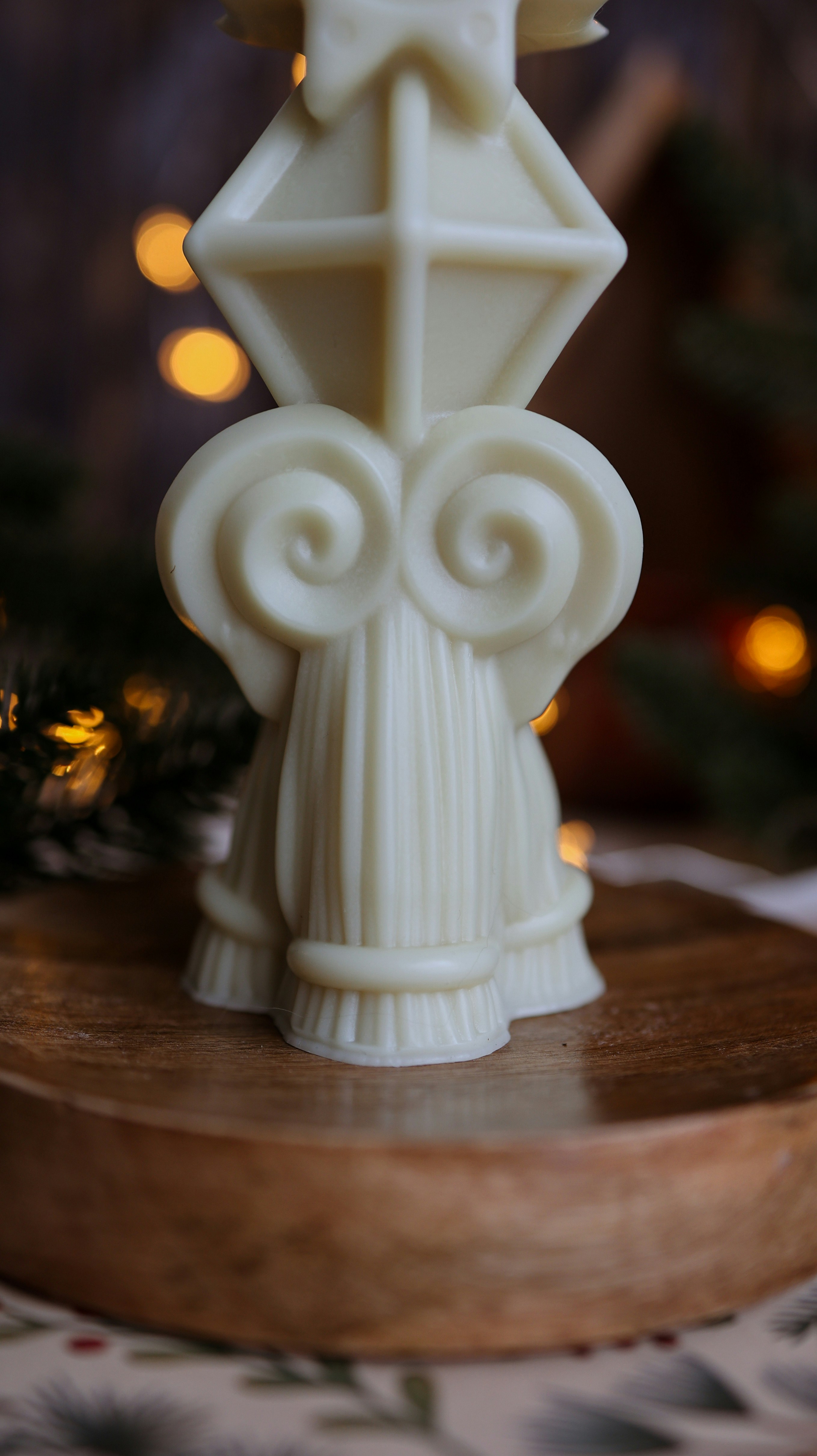Ivory Geometric Candle Ornament Bathed in a Warm Bokeh