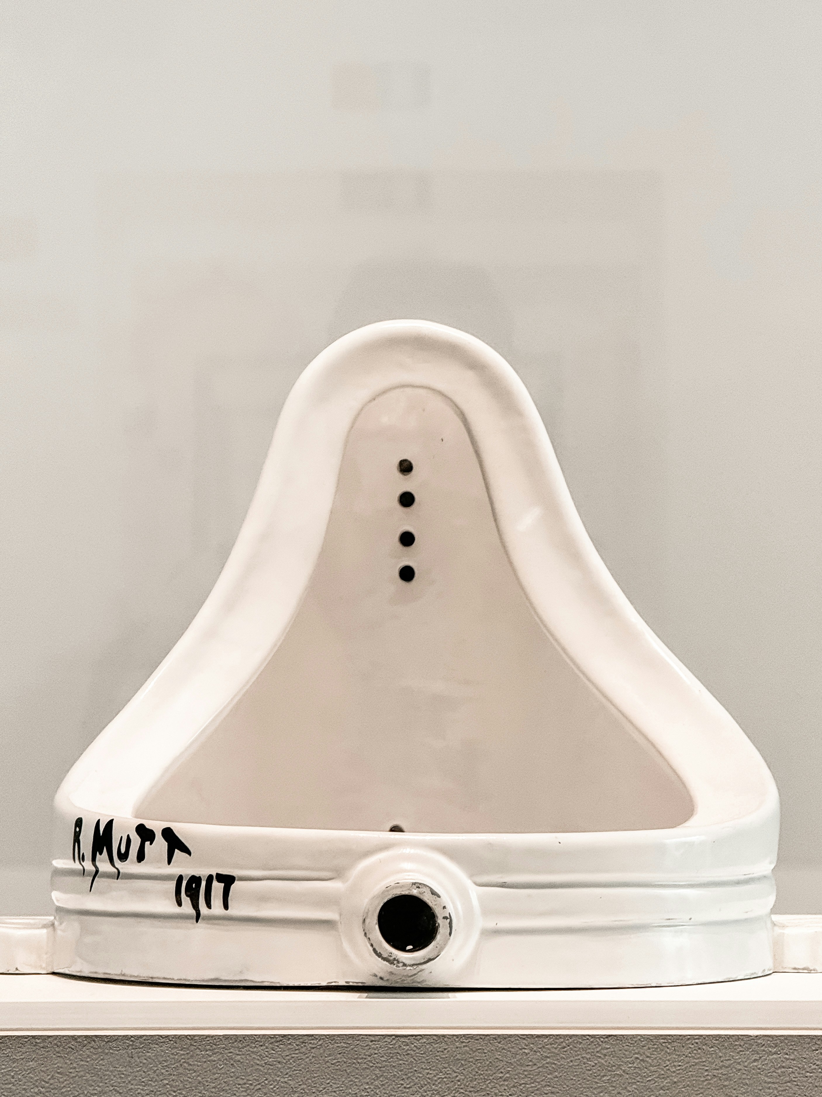 Quiet Geometry: A White Ceramic Form with a Dotted Spine