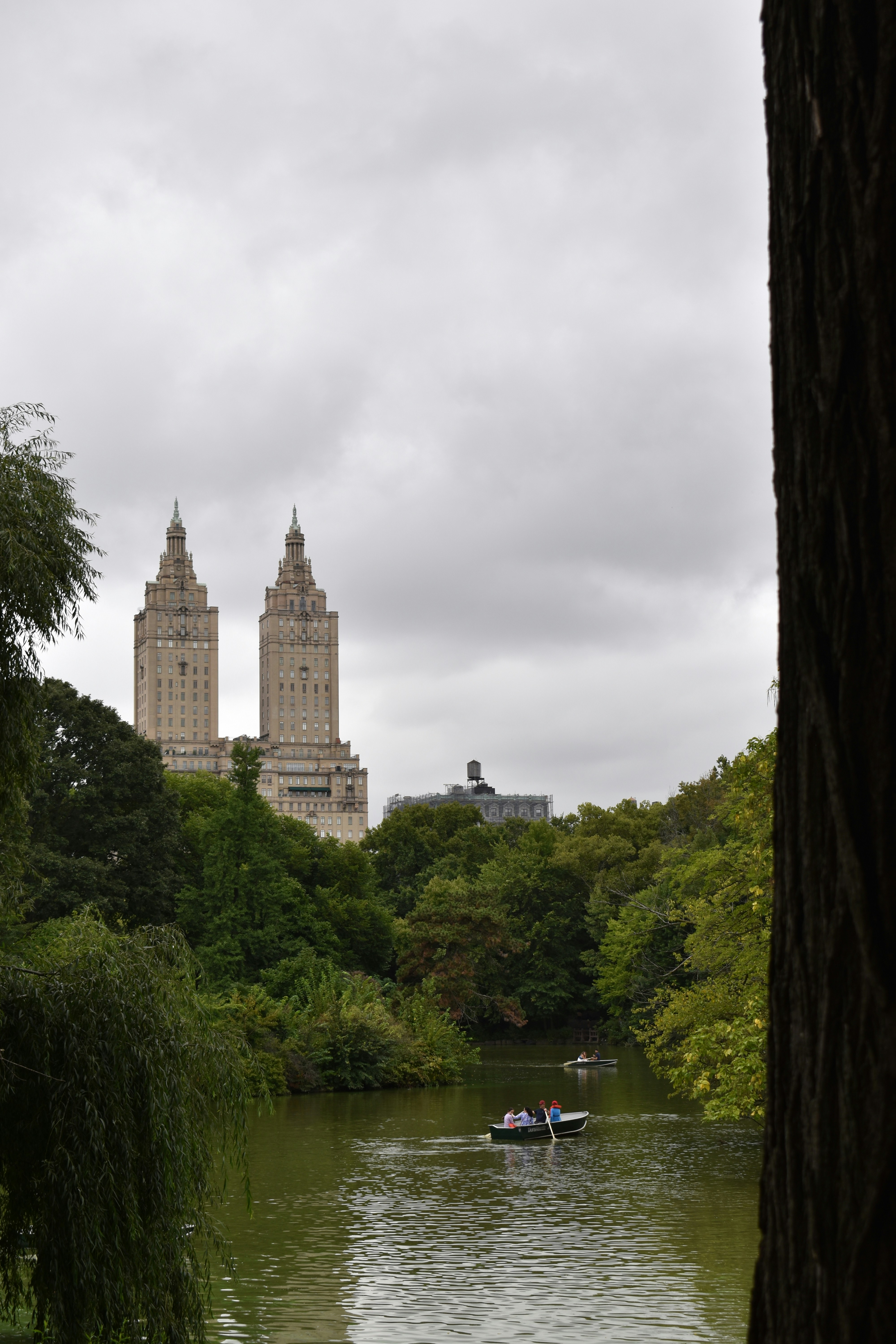 Mid-Canal Serenade: Boat beneath City Towers