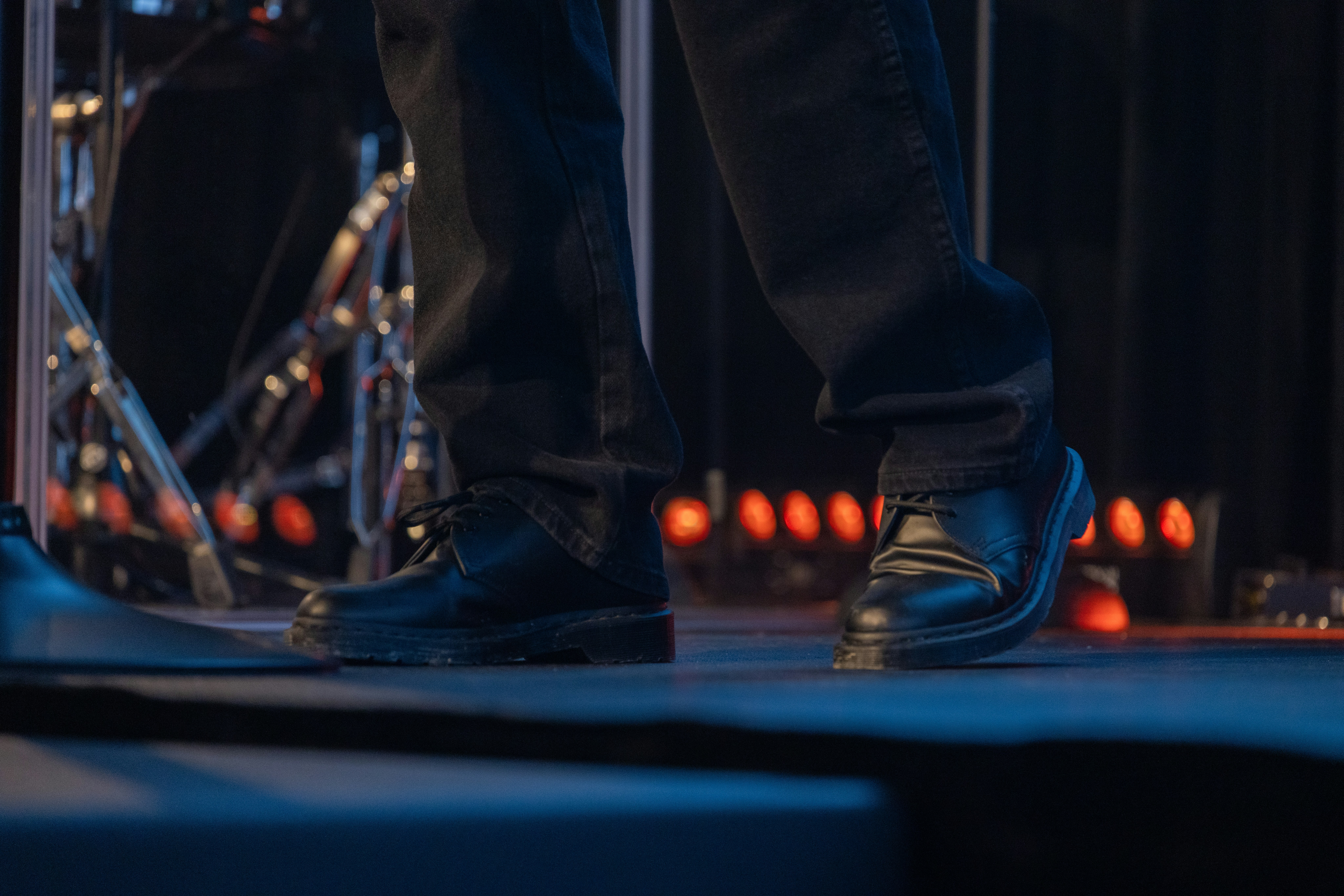 Una persona de pie en un escenario con un micrófono foto – Imagen de ...