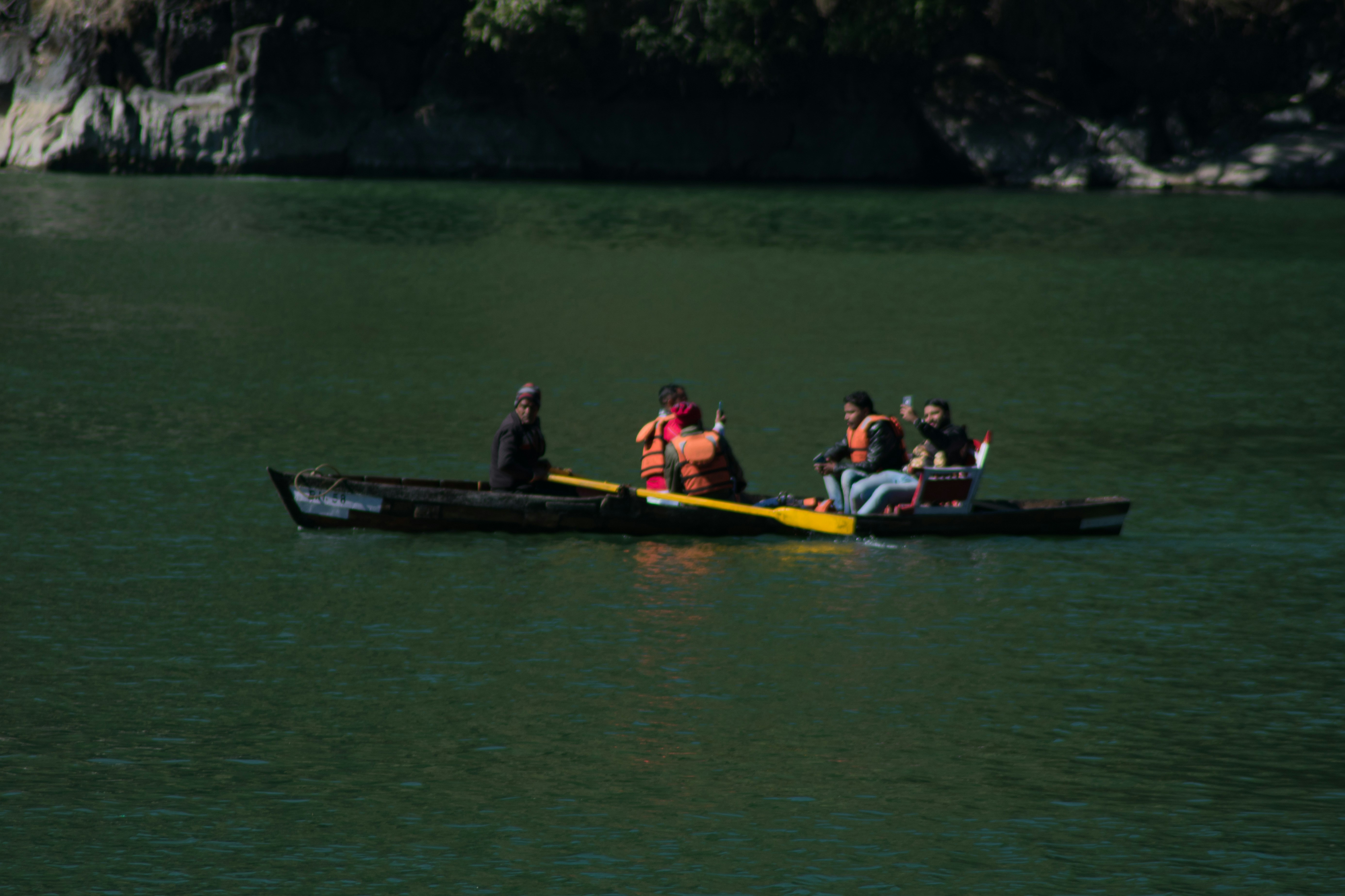 A group of people riding on the back of a boat photo – Free Human Image ...