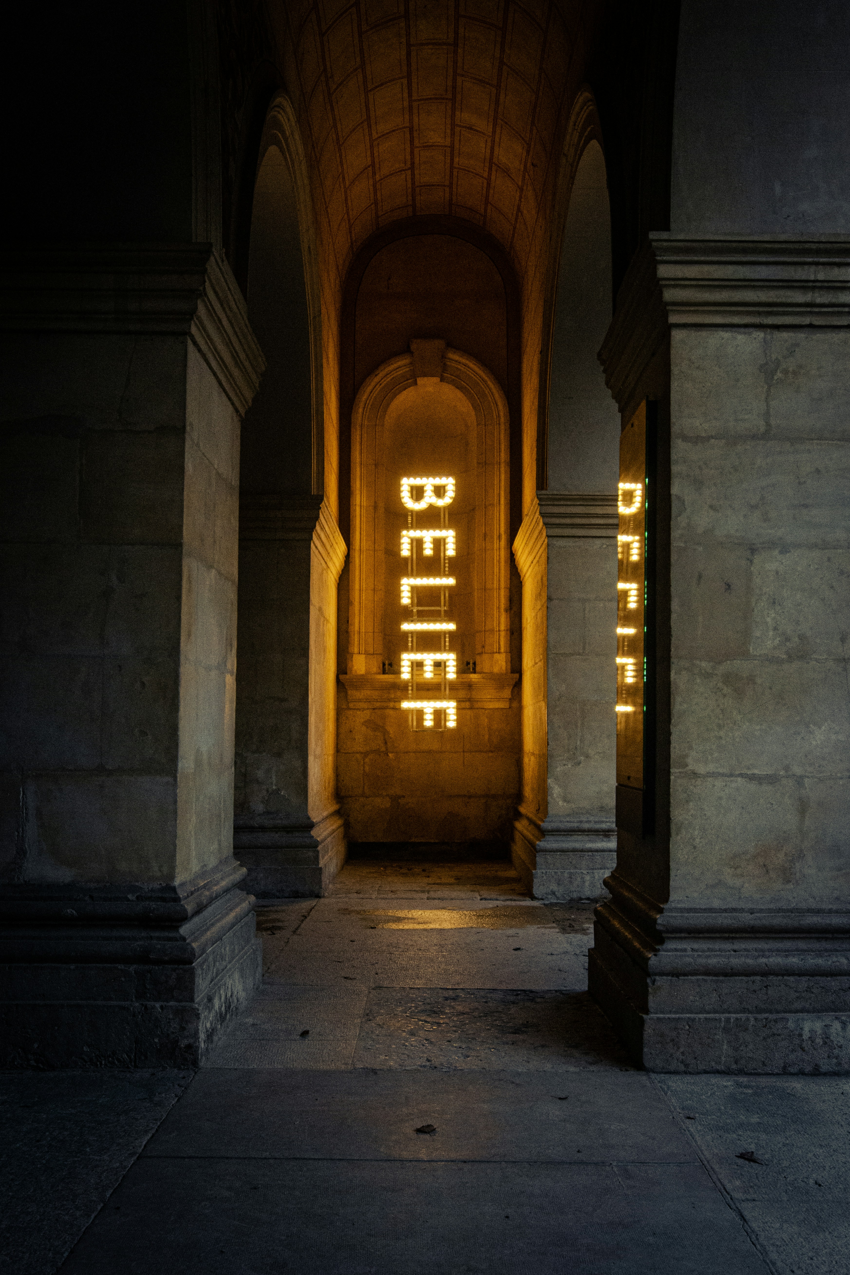 A dimly lit entrance to a building at night photo – Free Spirituality ...