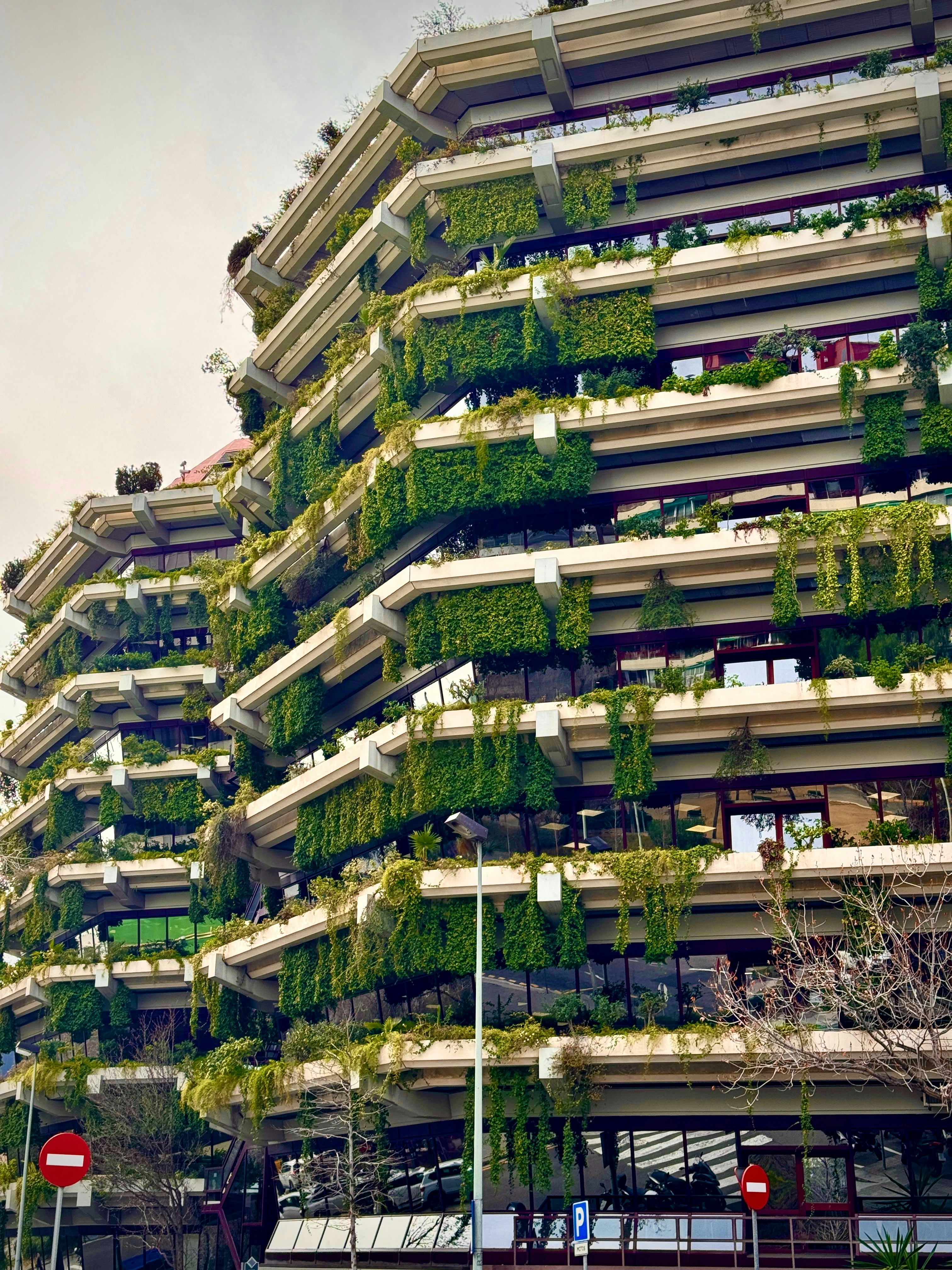 Verdant Slopes: The Living Facade Rises on a Concrete Spine