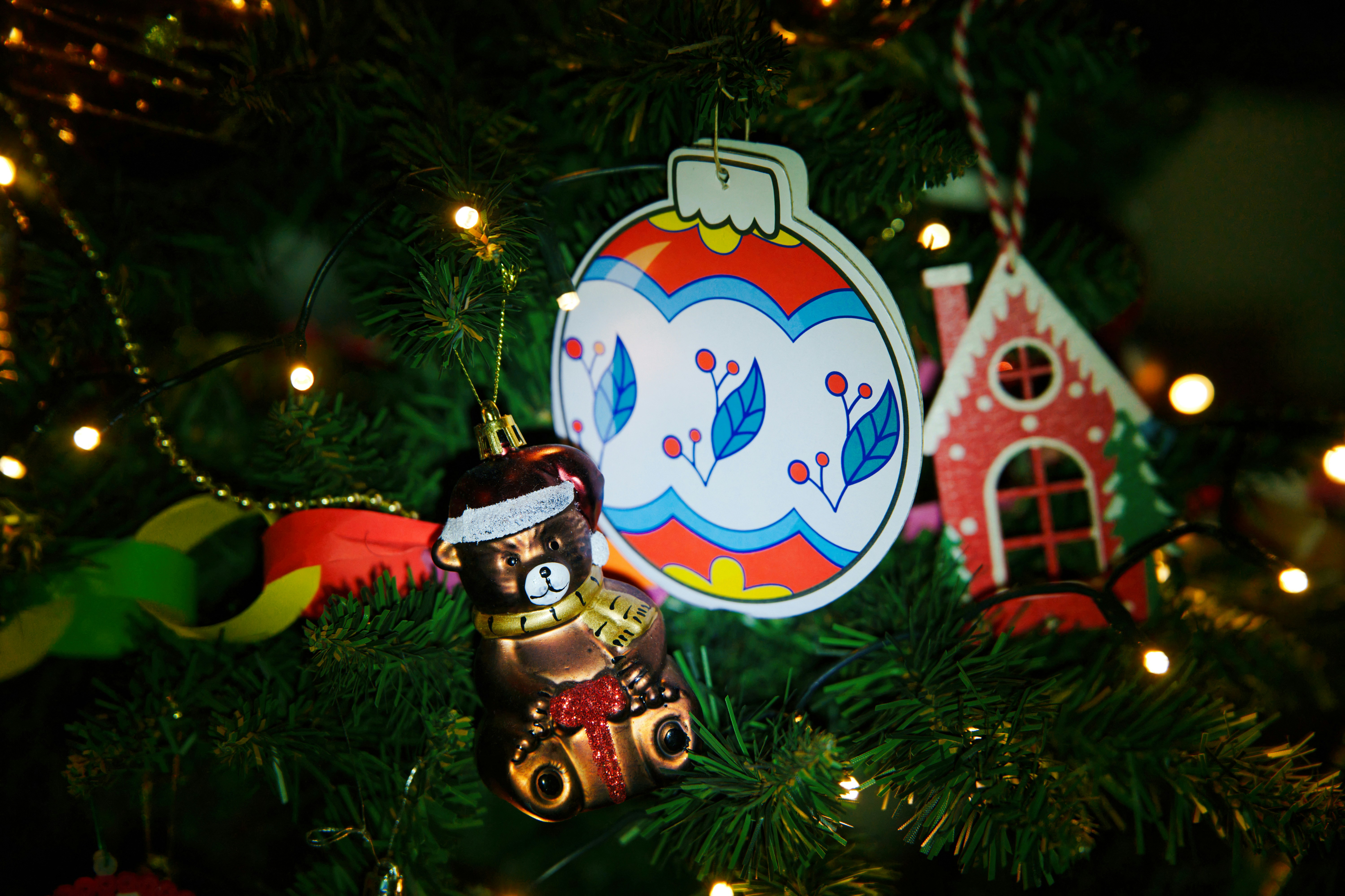 The Golden Bear and the Frosted Ornament: A Quiet Moment on a Twinkling Christmas Tree