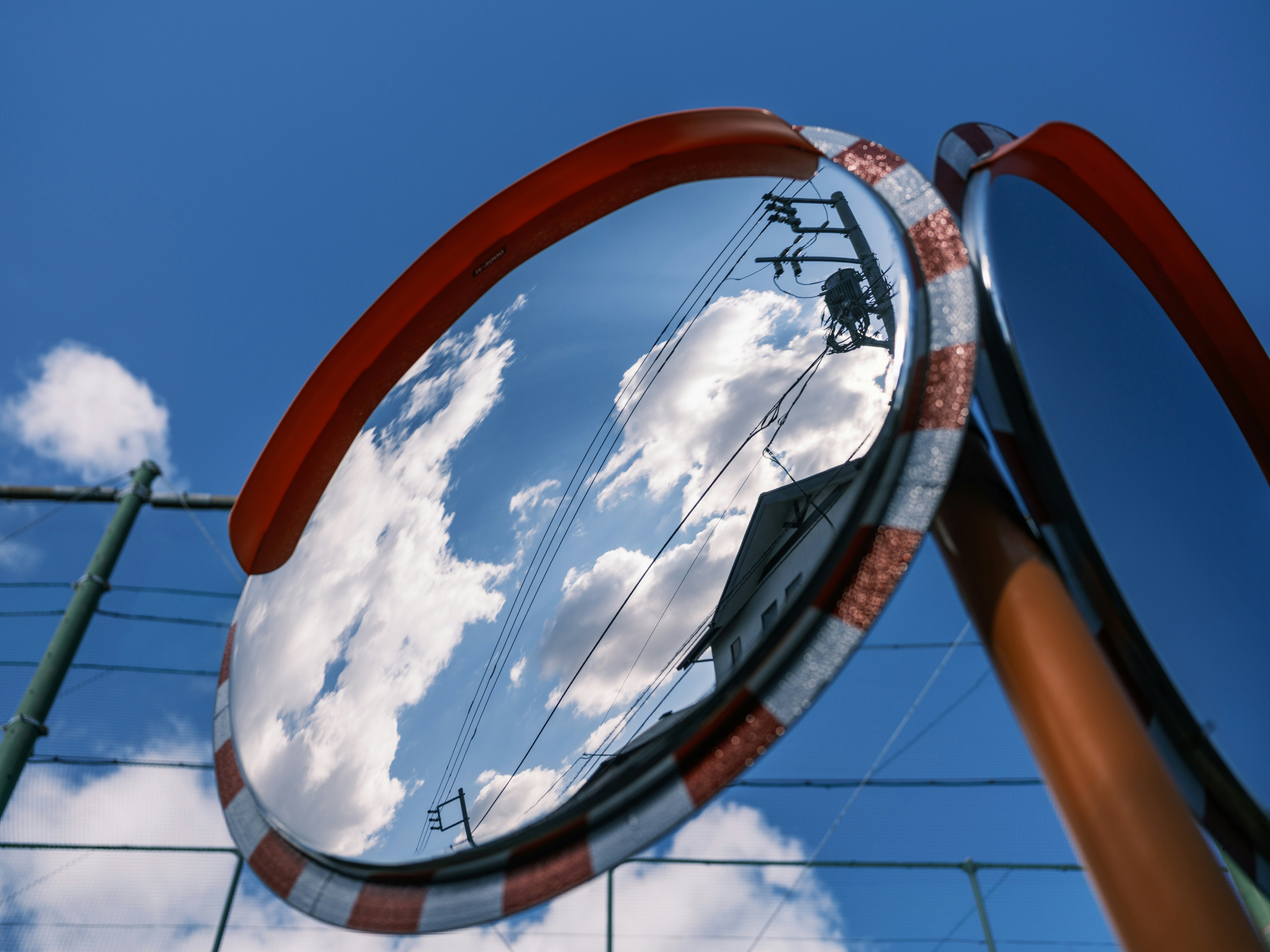 Kaleidoscope of Sky and Steel: A Playground Roundabout Reflected