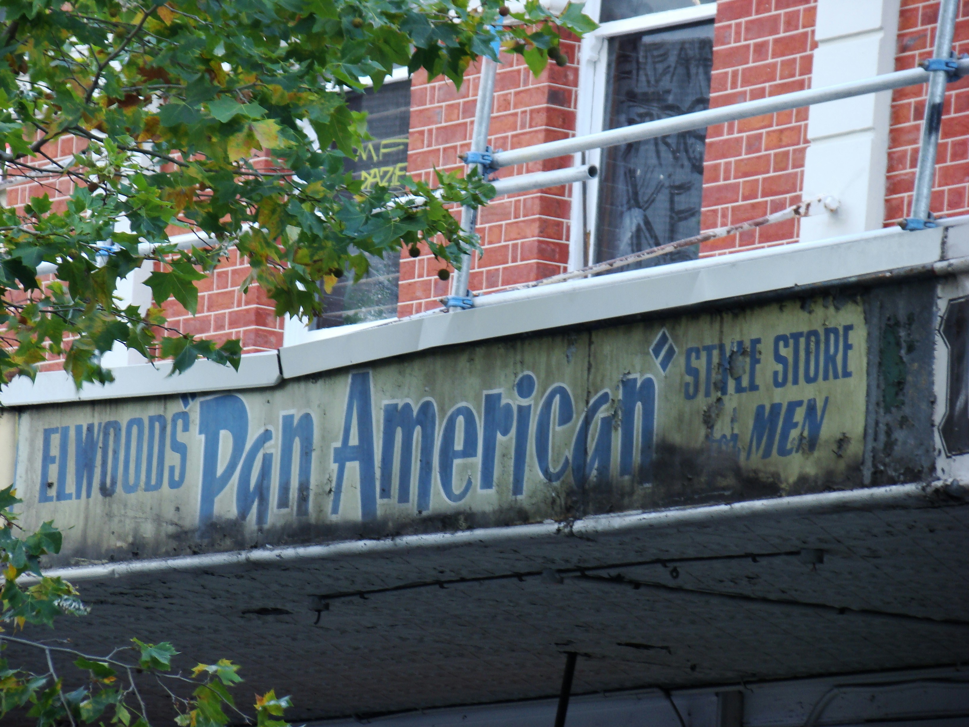 A sign on the side of a building that says lenwood's pan american photo ...