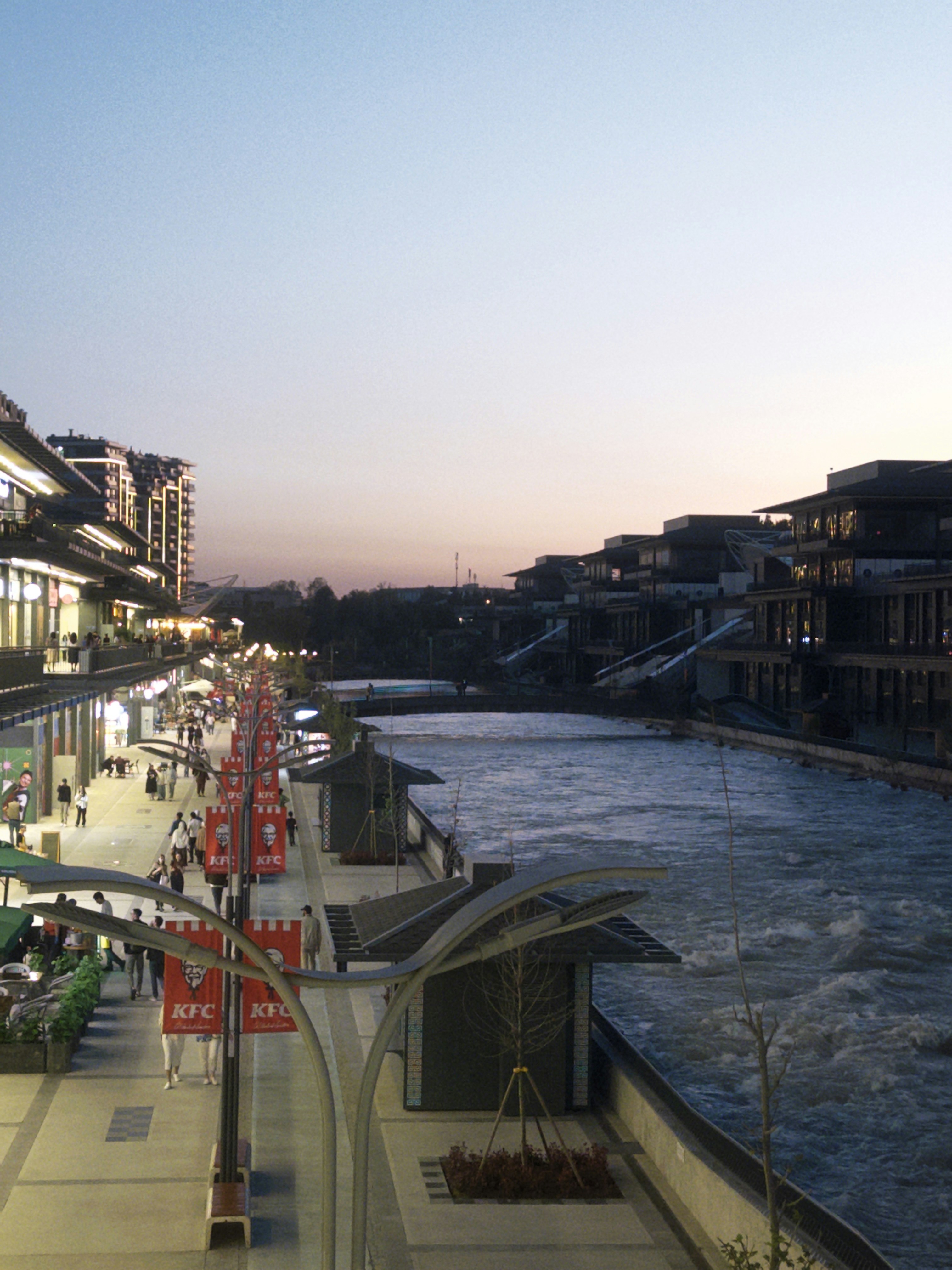 Dusk Along the Riverside Promenade: Red Banners and Waterlight