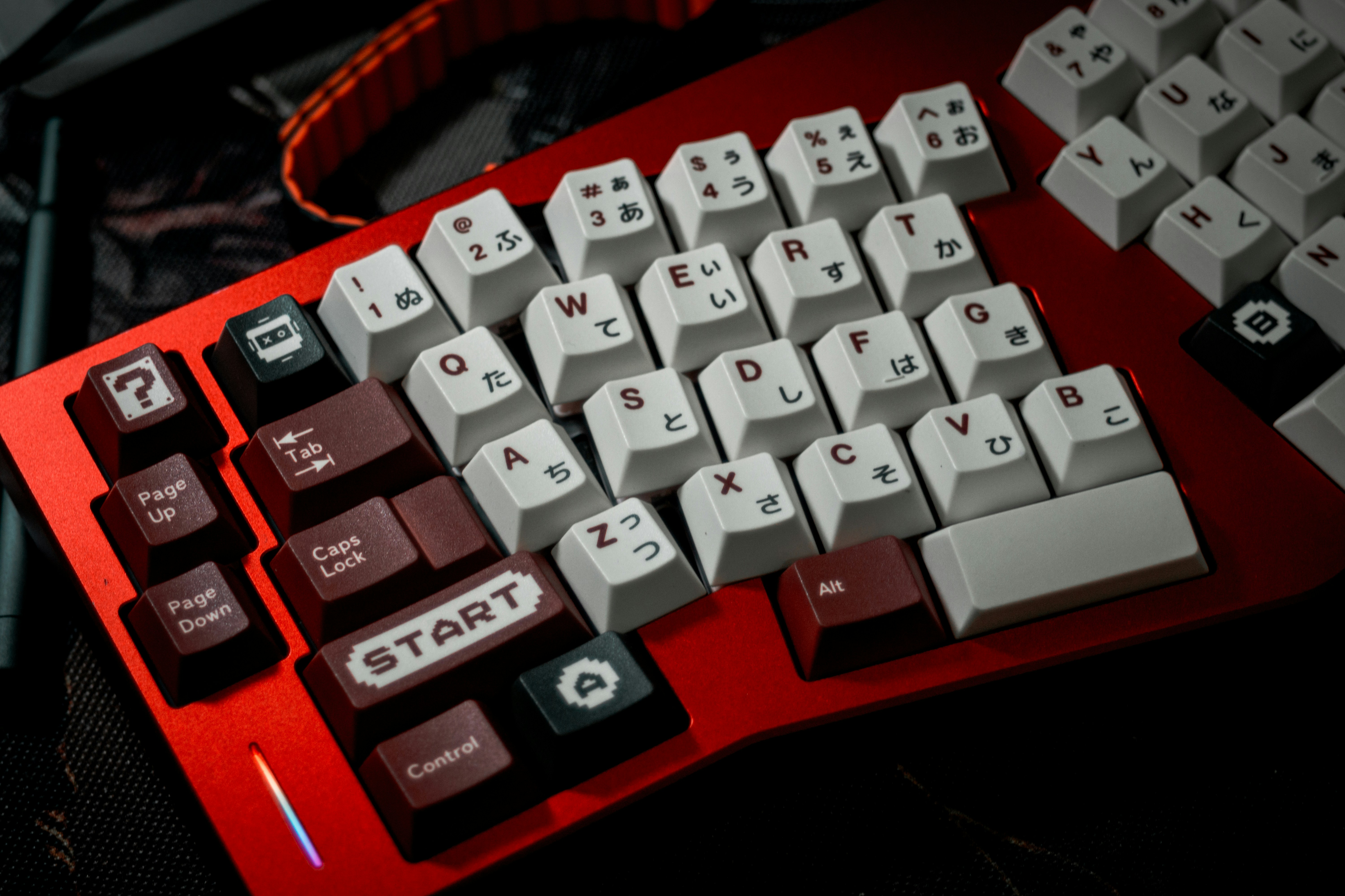 A computer keyboard sitting on top of a red table photo – Free Computer ...