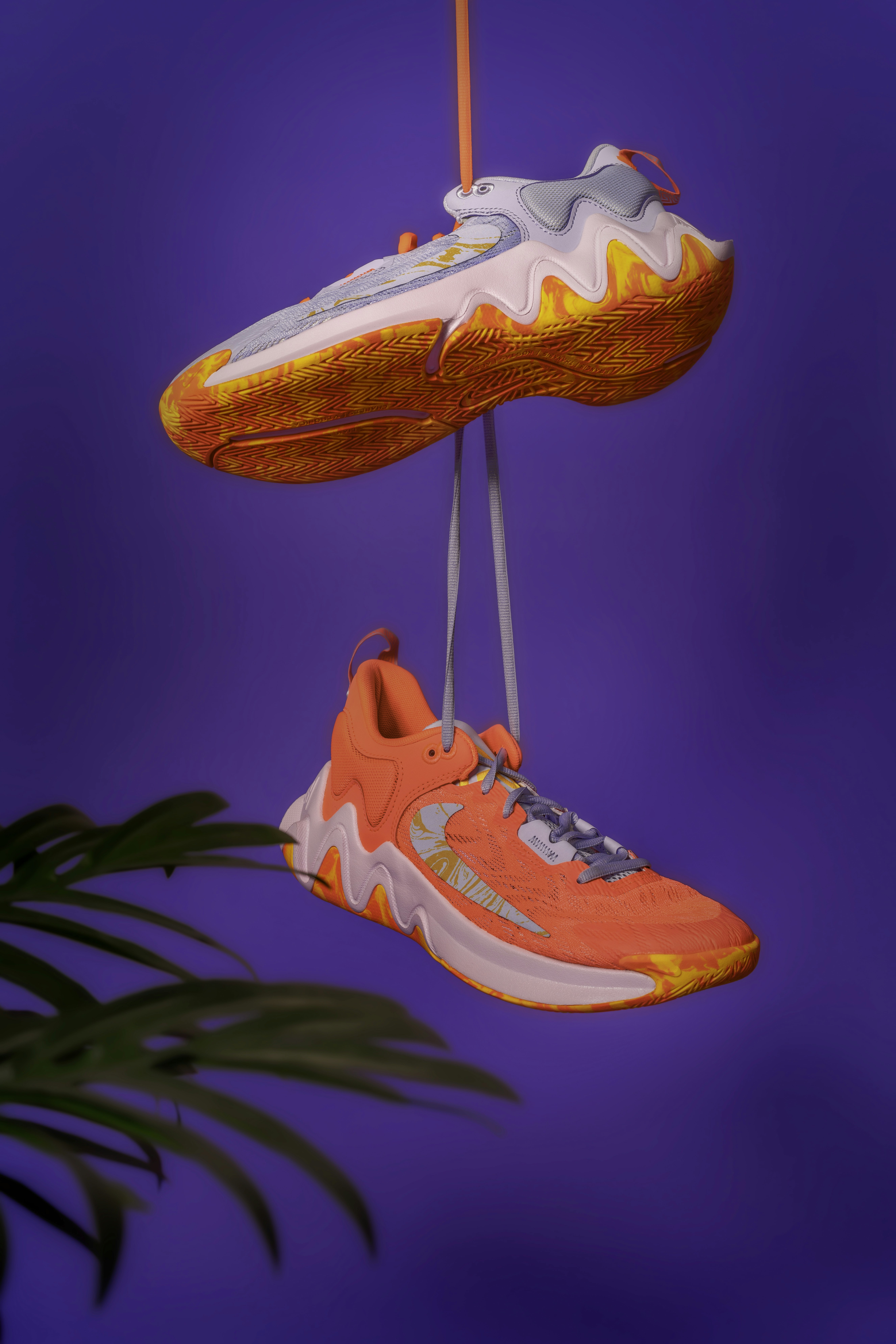 A bold and vibrant pair of Nike sneakers featuring dynamic orange, pink, and yellow accents, designed for style and performance.