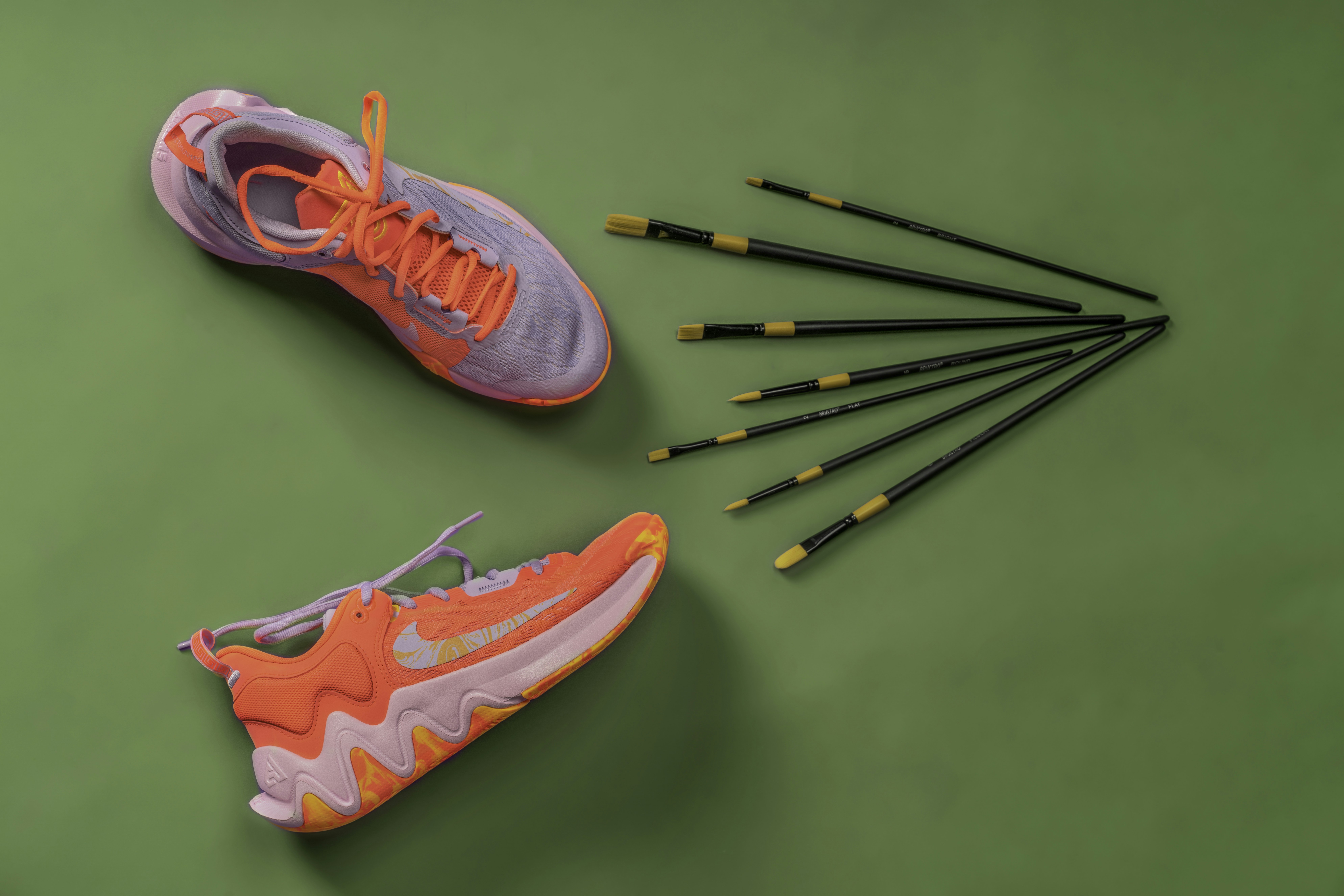 Neon Sneakers on a Mint Green Studio Floor with a Fan of Rods