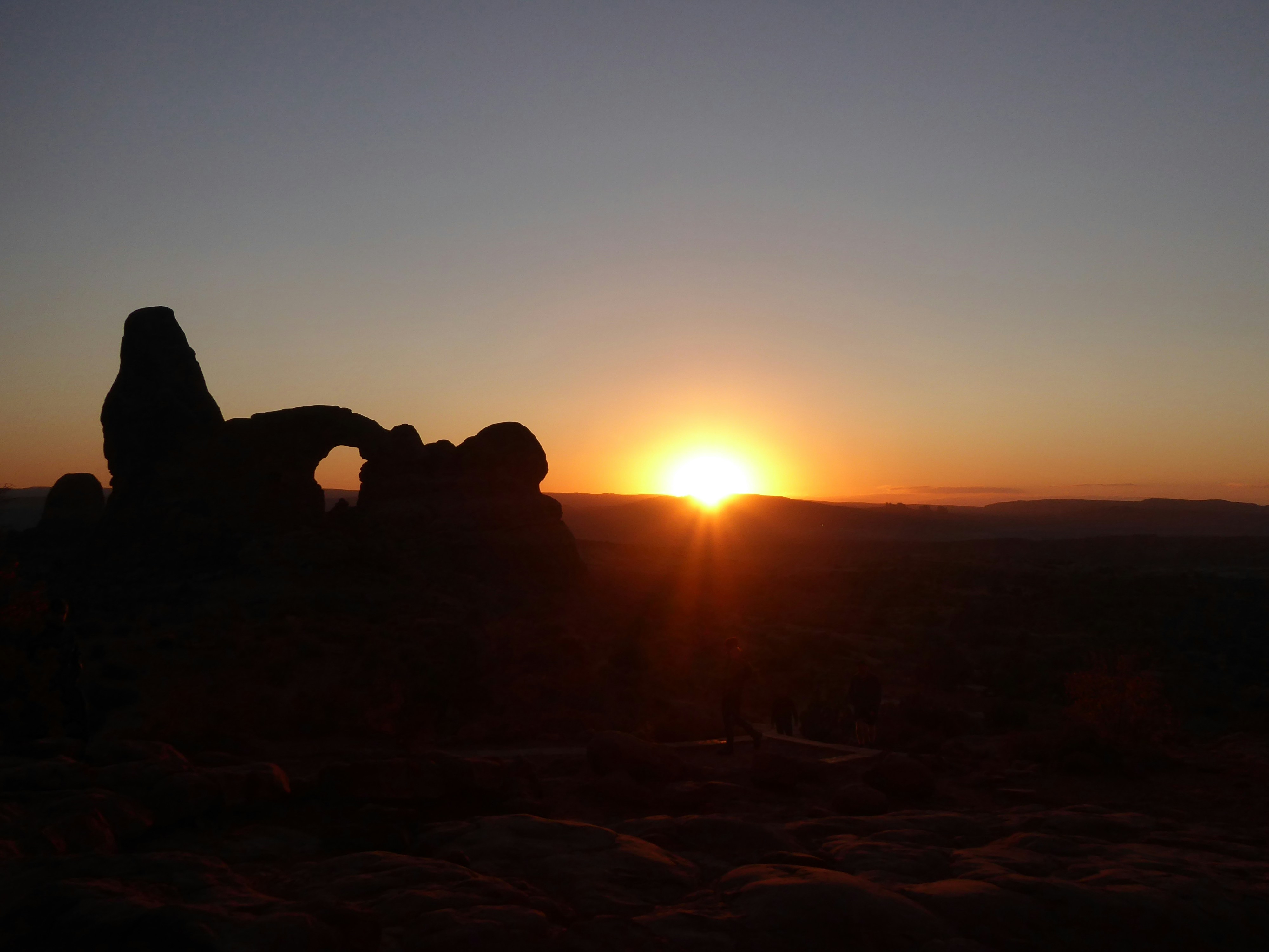 Sunrise over the Stone Arch: silhouettes at the edge of light