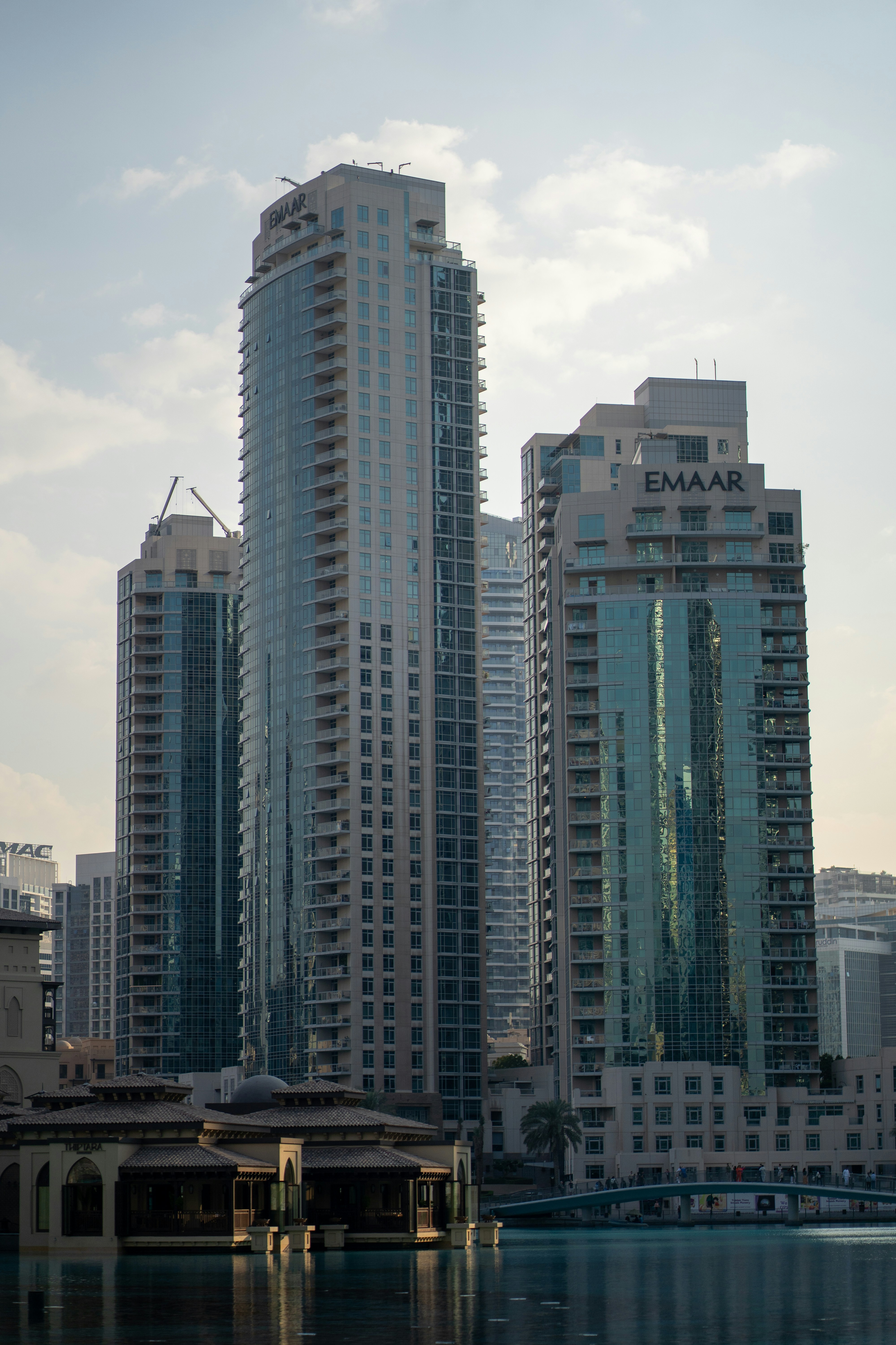 A large body of water in front of tall buildings photo – Free Burj ...