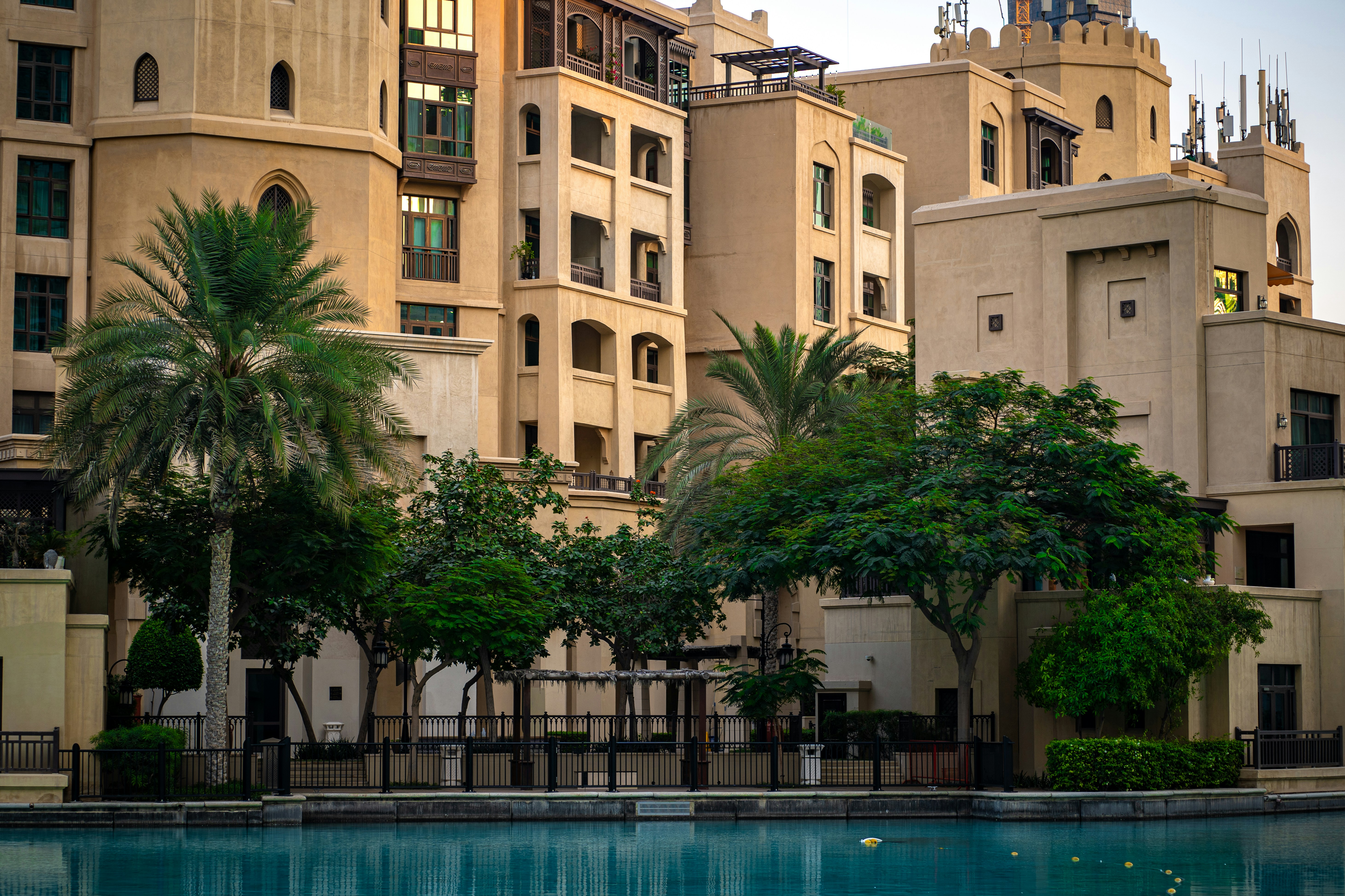 A large building with a pool in front of it photo – Free Building Image ...