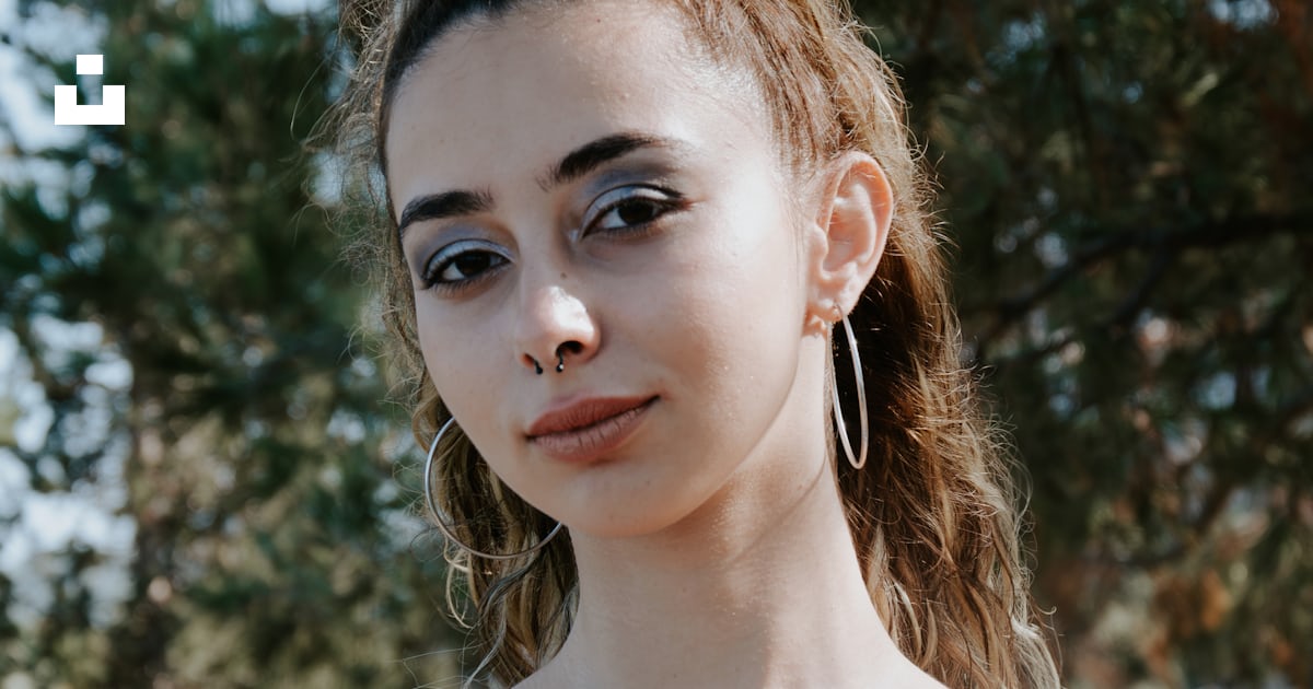 A Woman In A Striped Shirt Posing For A Picture Photo Free Face Image