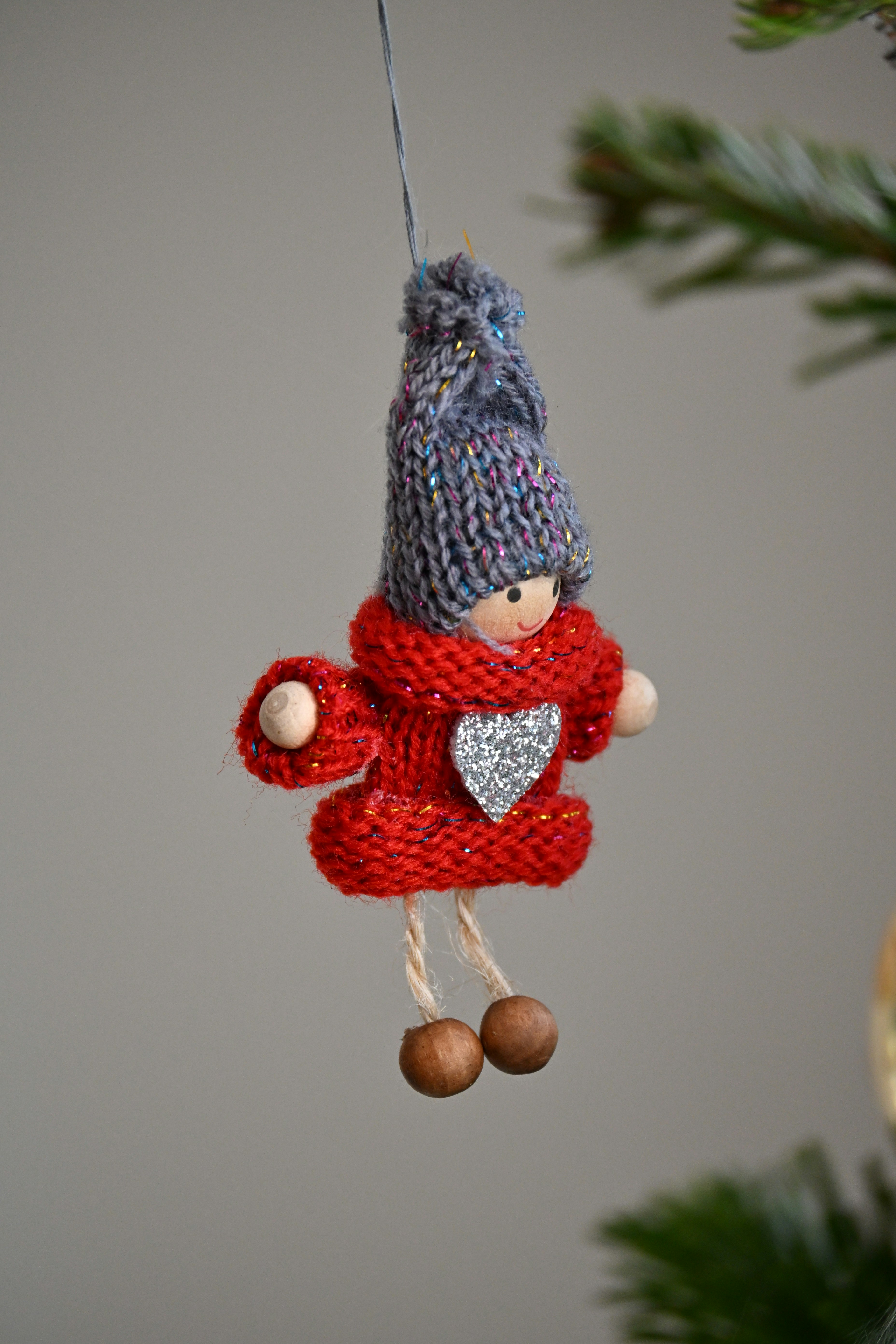 Knit Witch Ornament Hanging in Focus with Soft Background