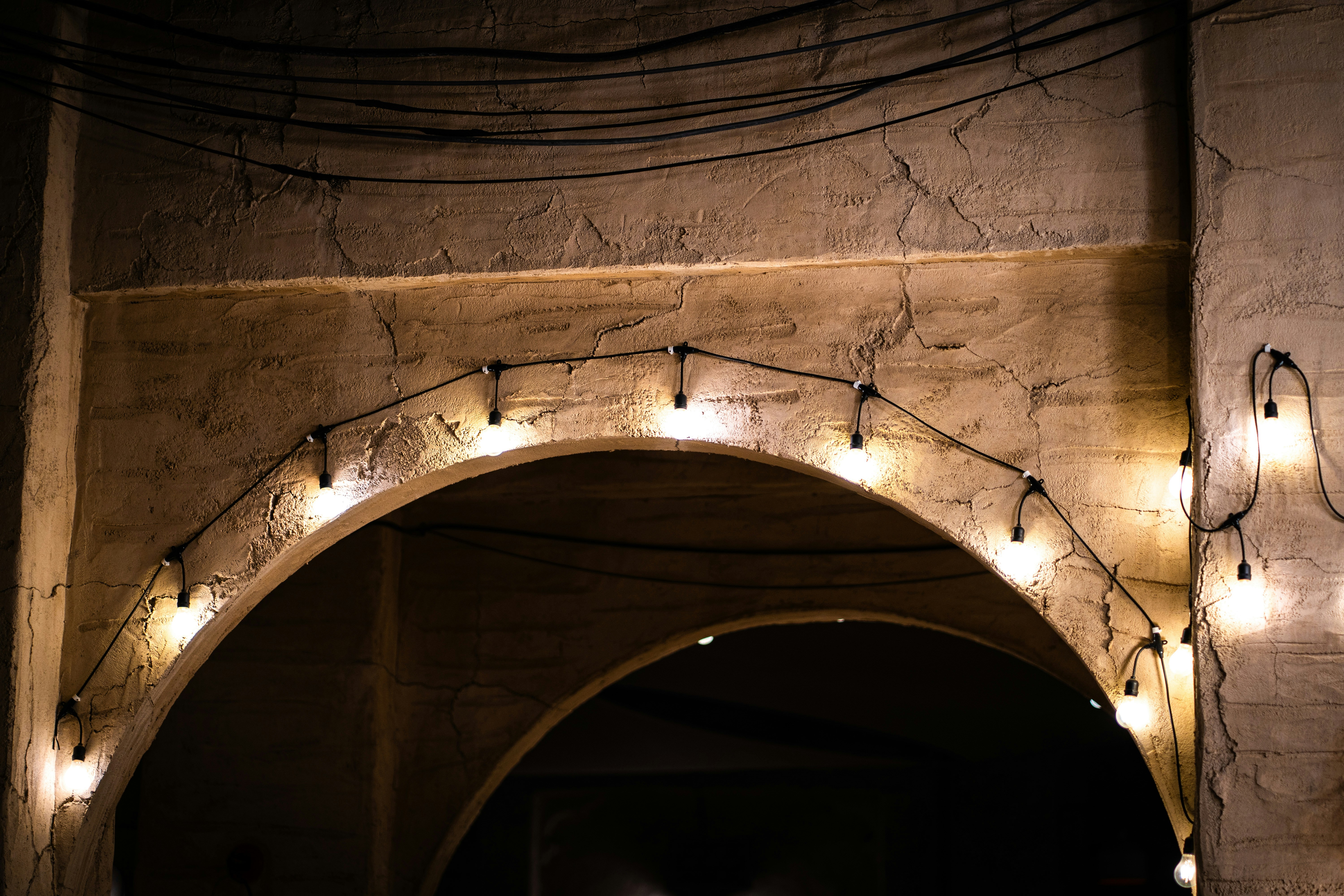 Archway in Warm Glow: String Lights Framing a Quiet Doorway