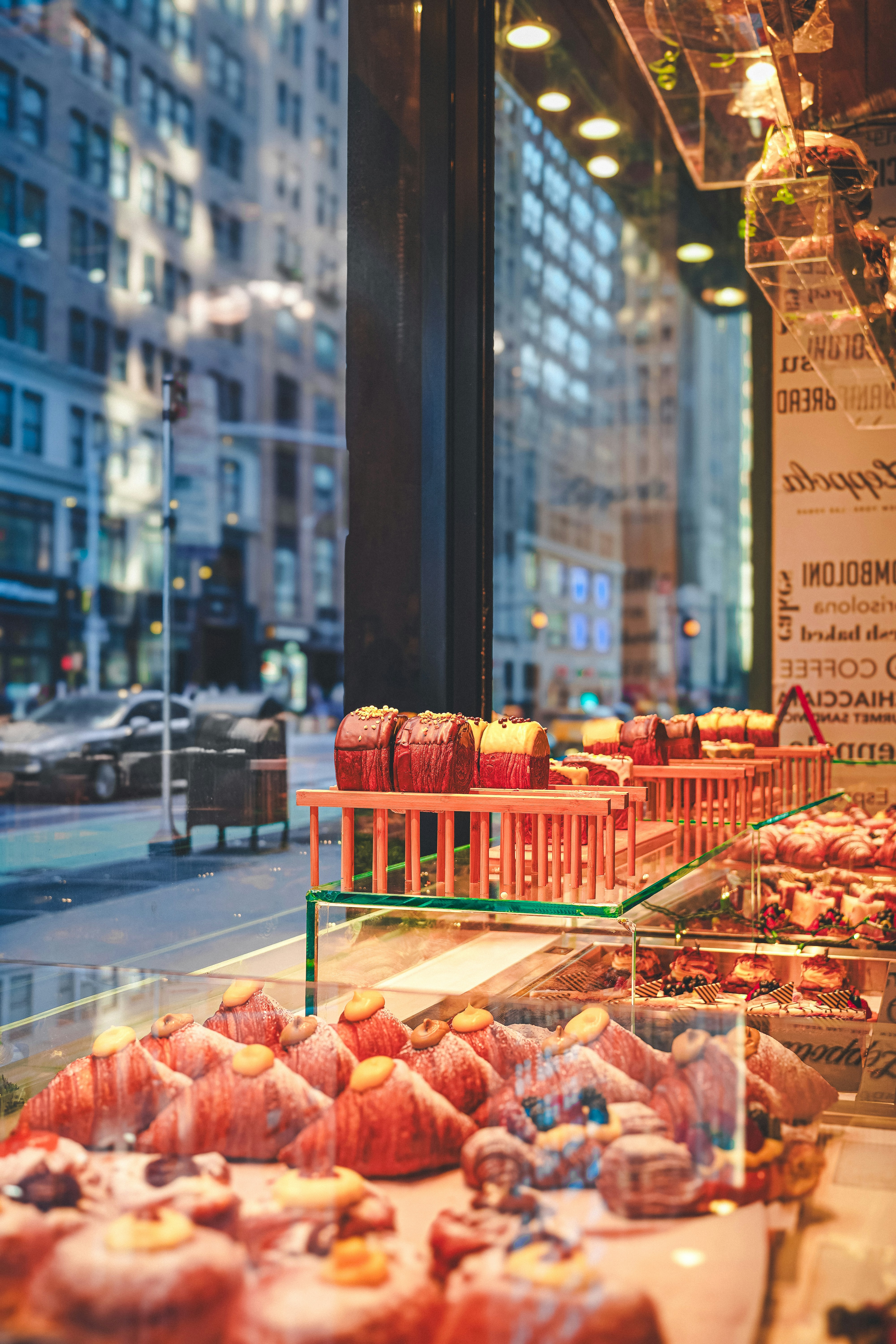 Neon Window Pastries: A Quiet Parade of Baked Delights in a City Shopfront