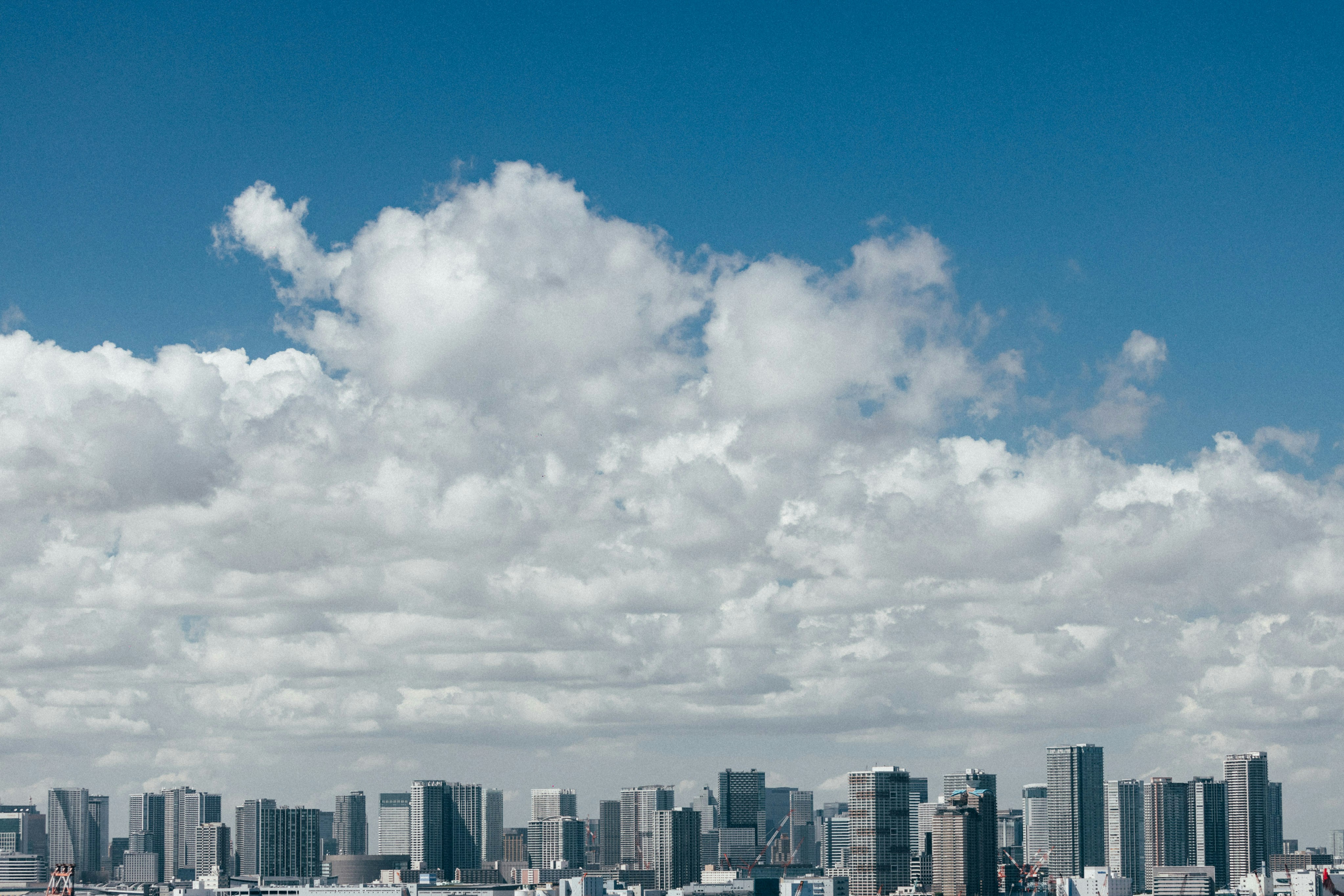 A view of a city skyline with clouds in the sky photo – Free Cloud ...