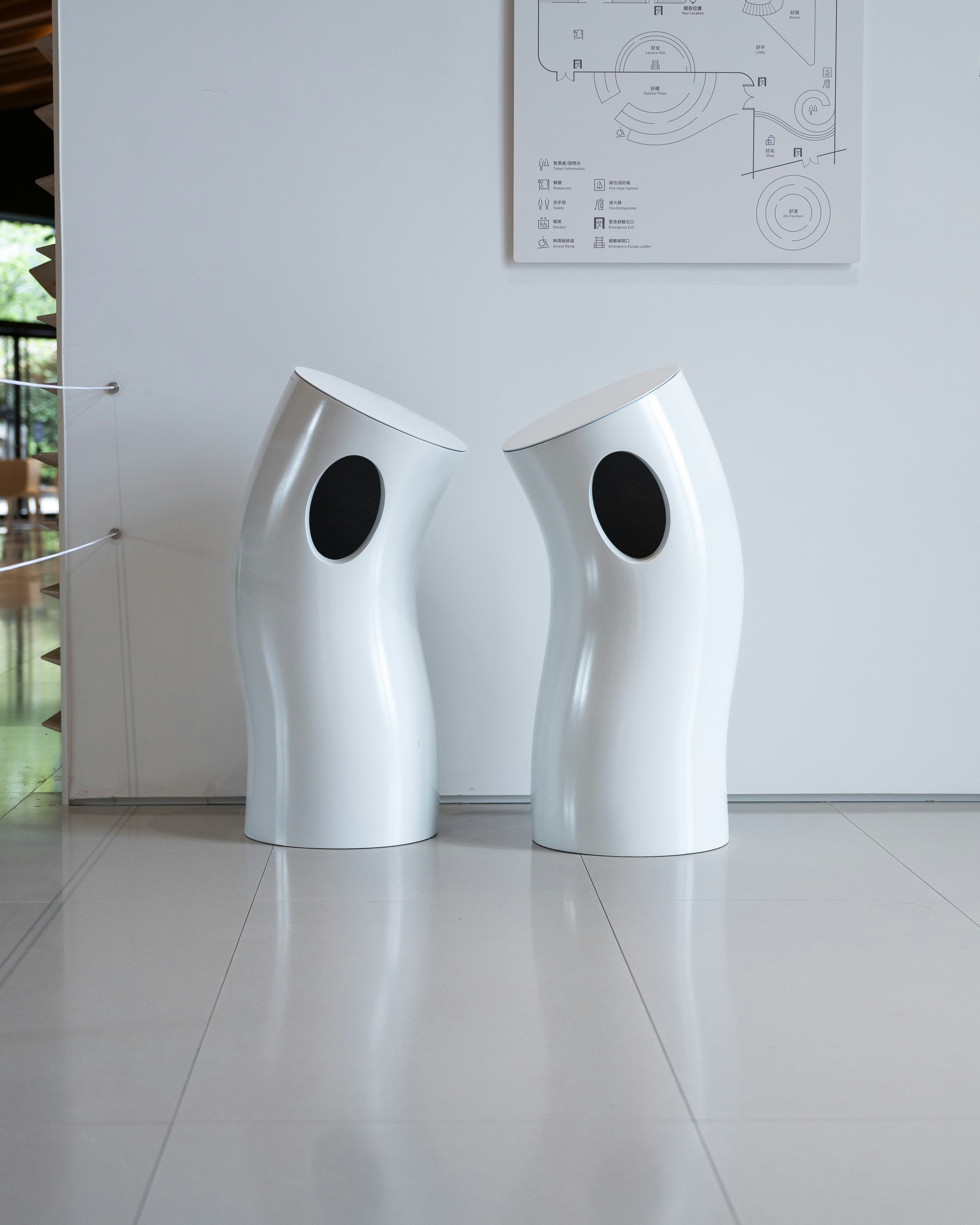 Sinuous Duet: White Sculptures in a Quiet Gallery