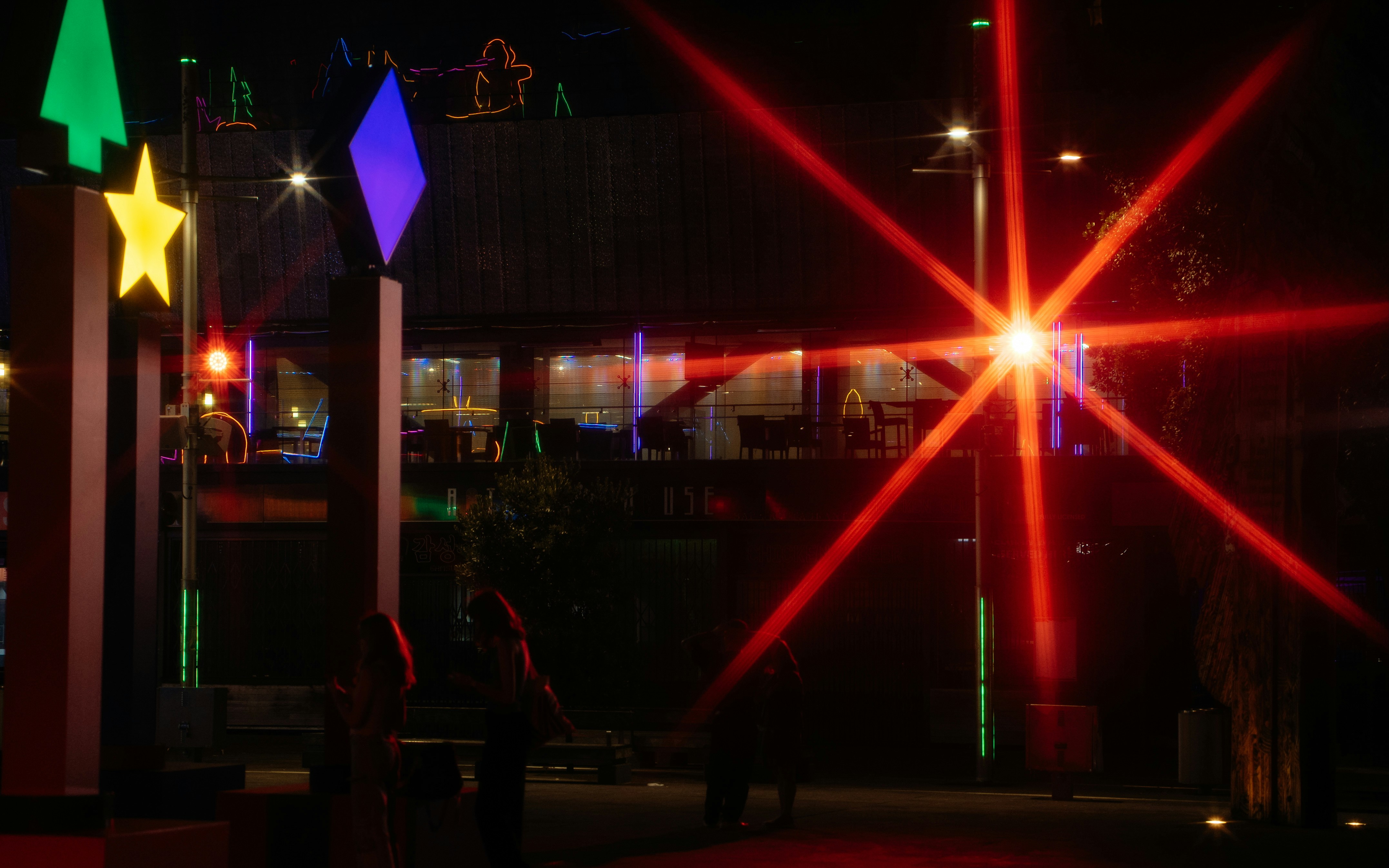 Crimson Starburst Over Neon Nightscape