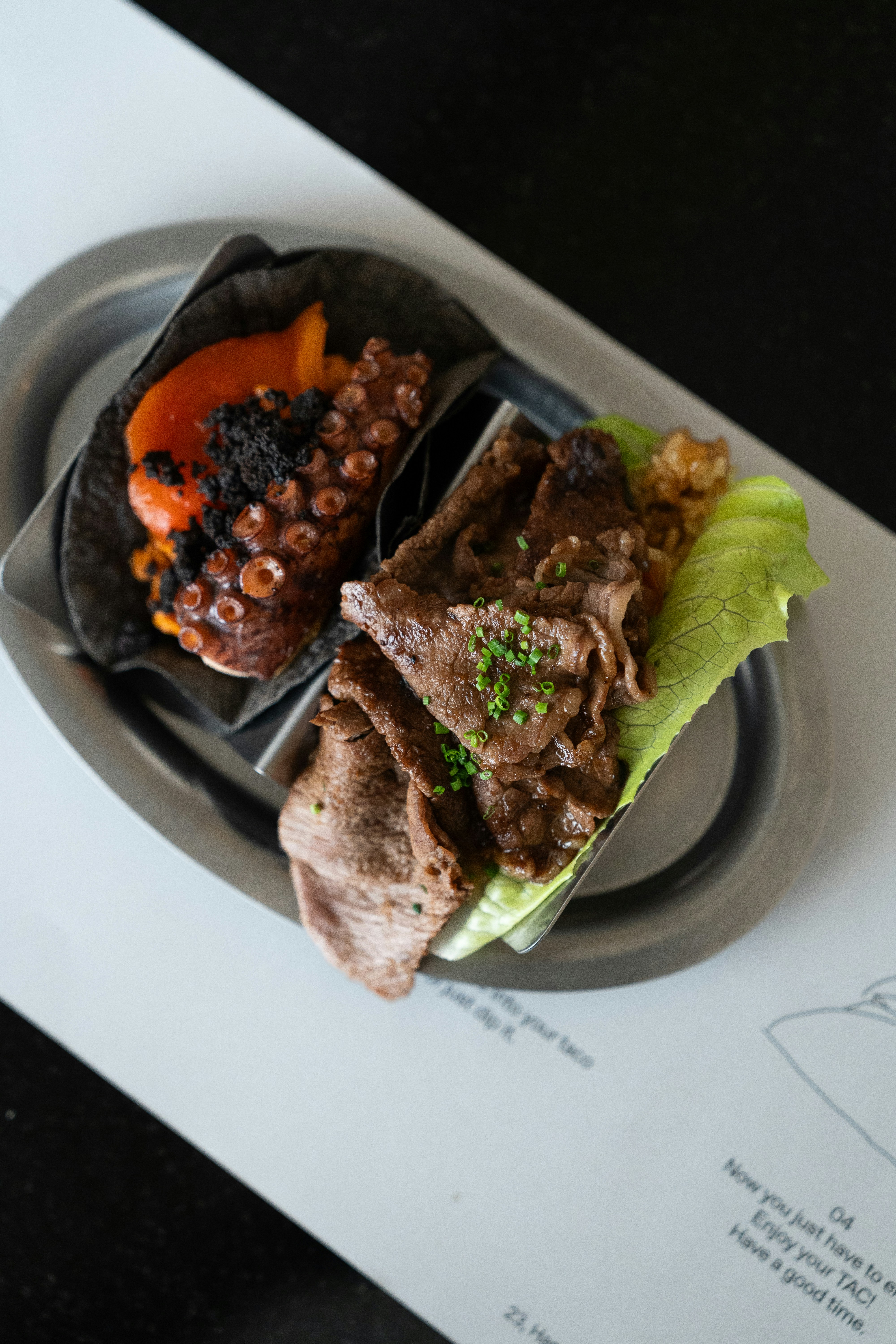 Charred Octopus and Roast Beef on Lettuce Propped in a Modern Platter