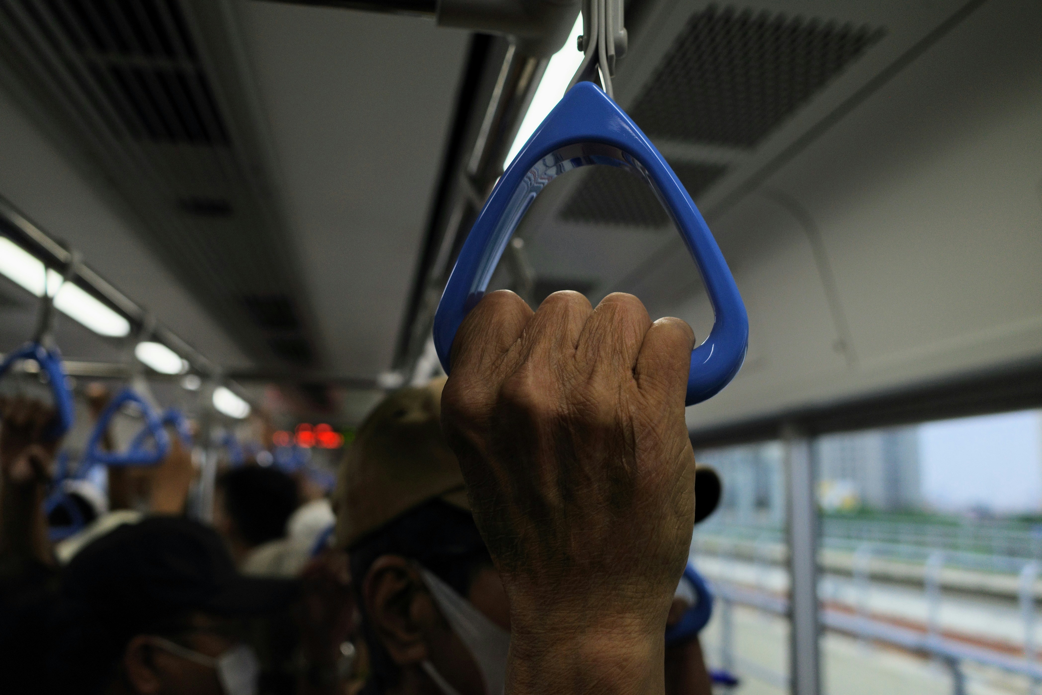 A group of people riding on a train next to each other photo – Free Ben ...