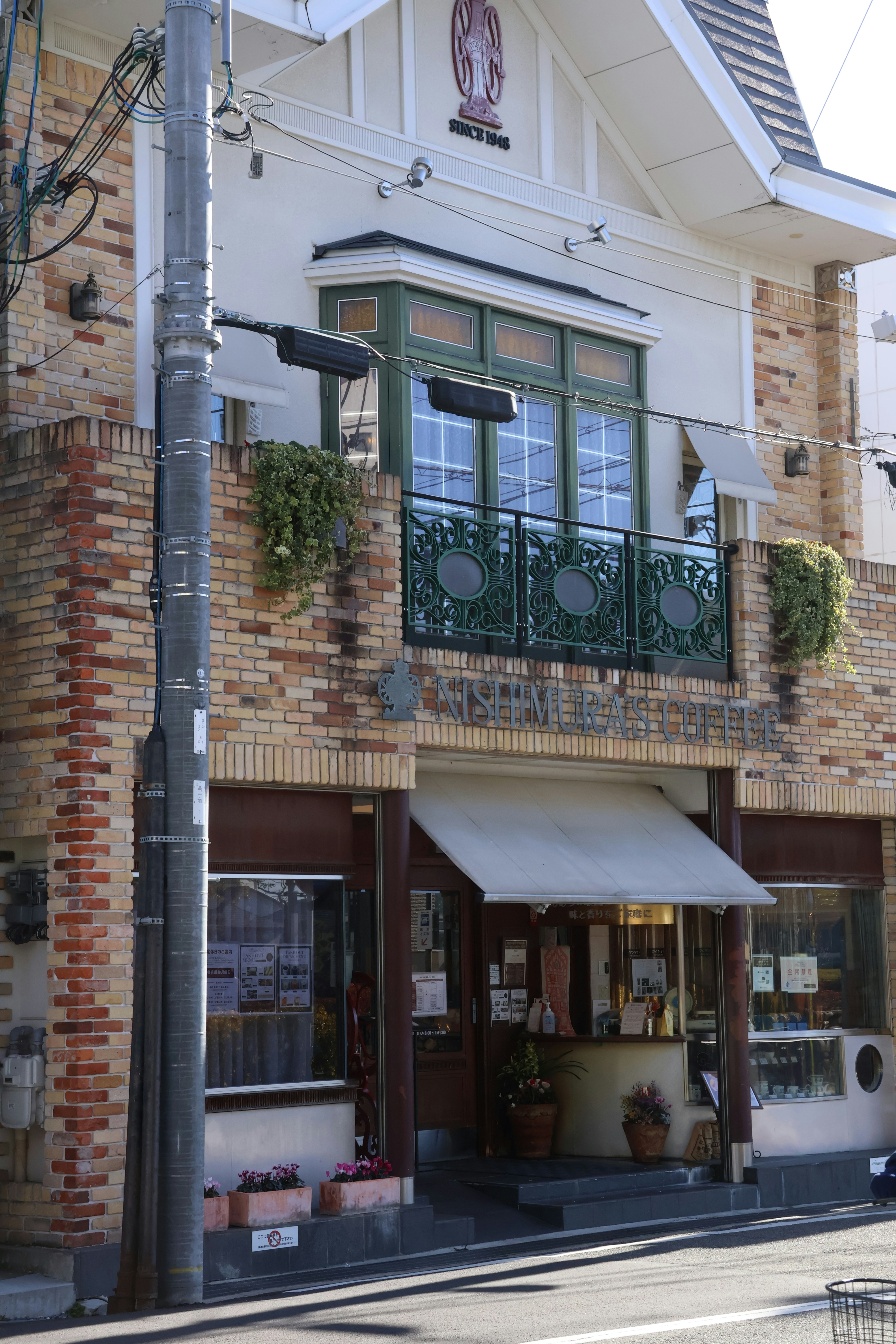 A brick building with a balcony and a store front photo – Free ...