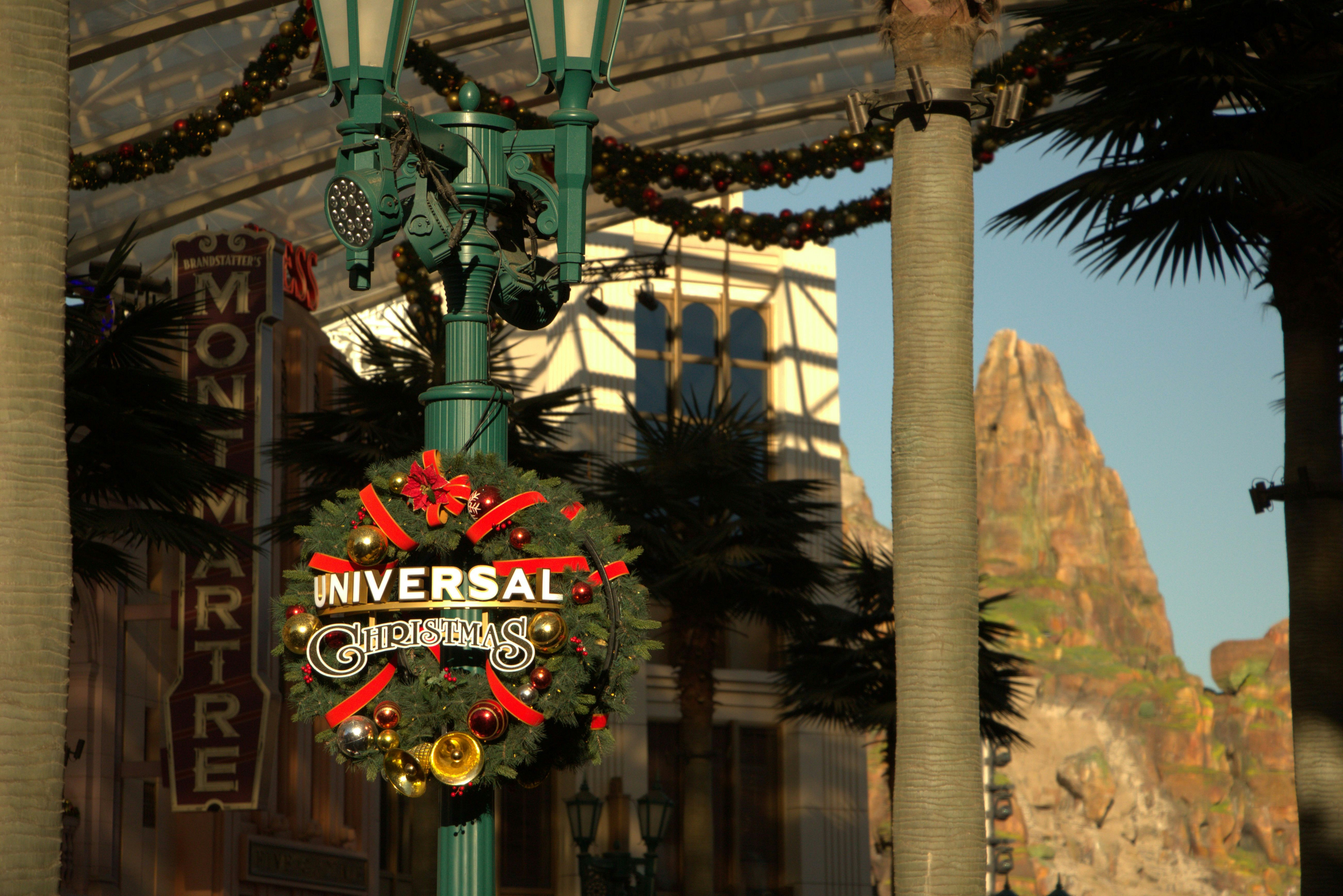 A street light with a christmas wreath on it photo – Free Universal ...