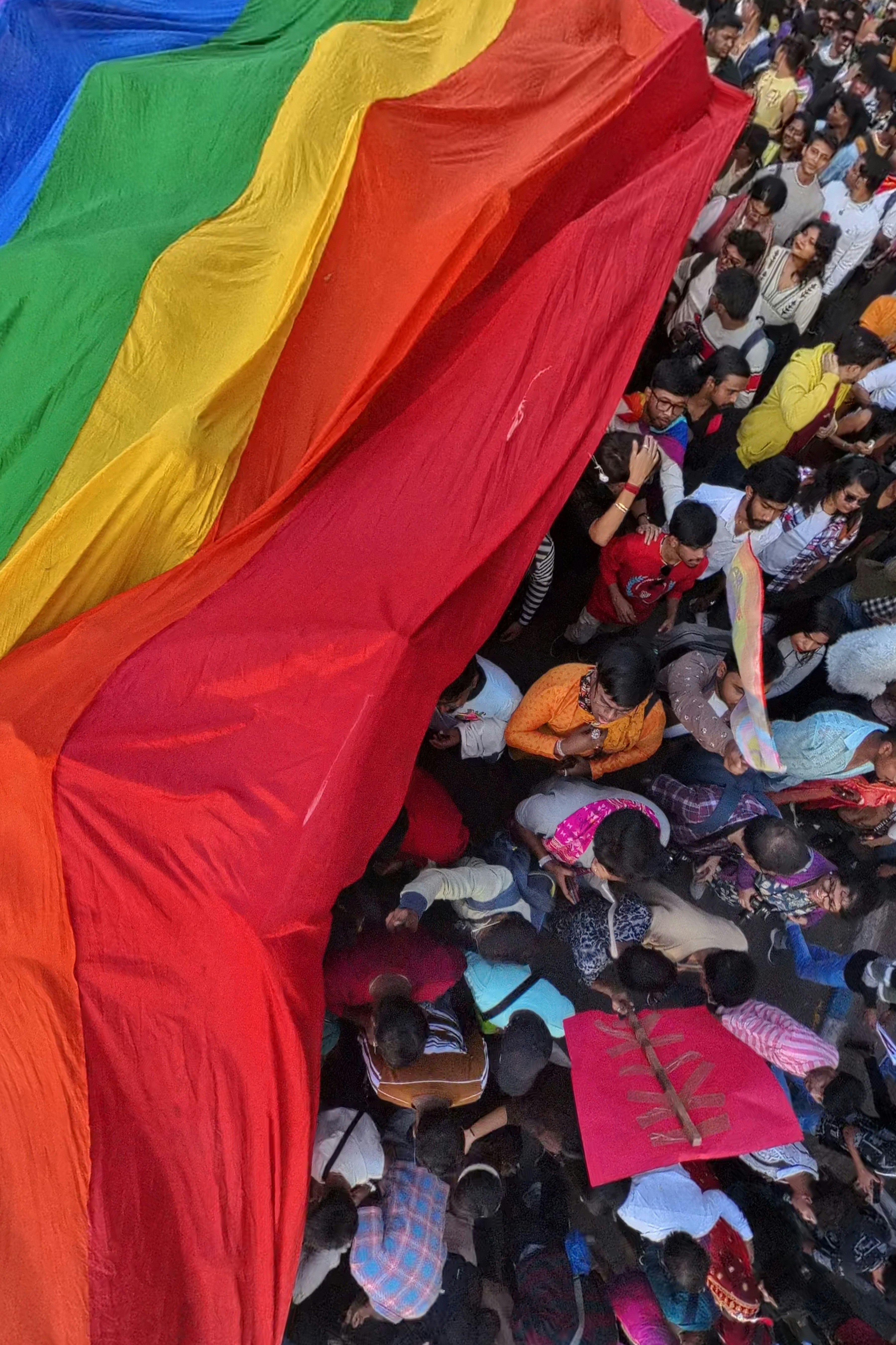 A large group of people standing around a rainbow flag photo – Free Background Image on Unsplash