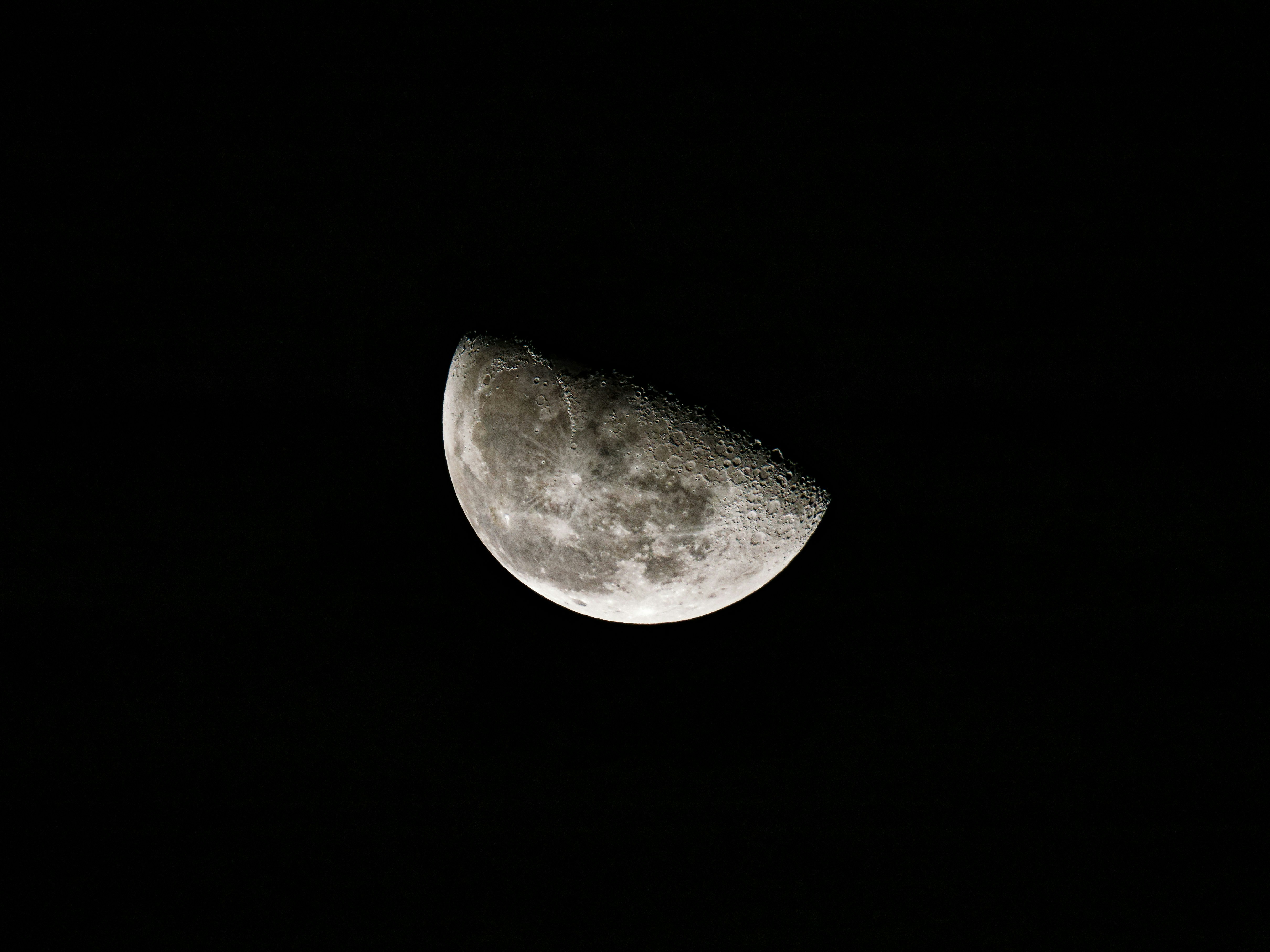 A half moon is seen in the dark sky photo – Free Moon Image on Unsplash