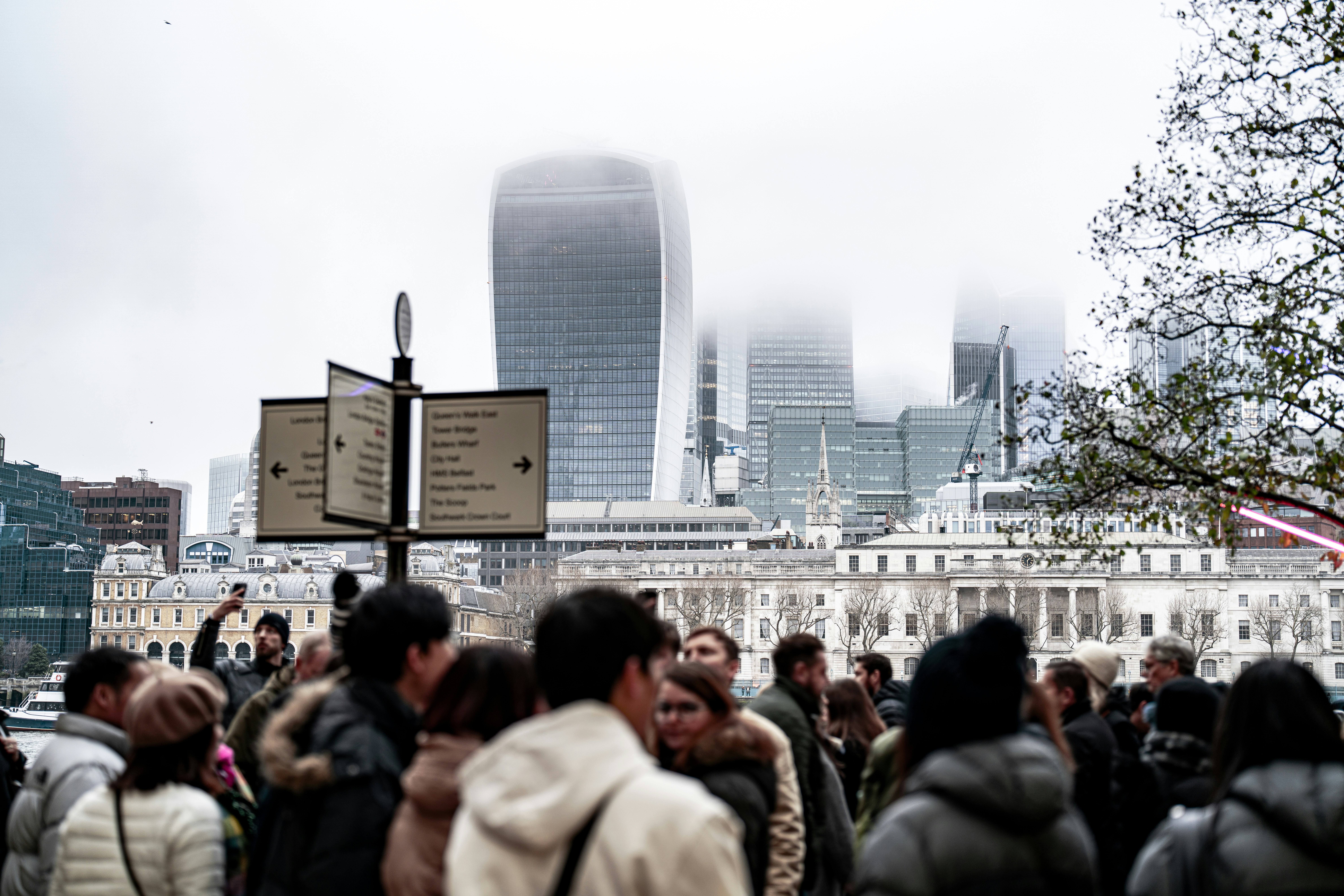 A crowd of people standing in front of a tall building photo – Free ...