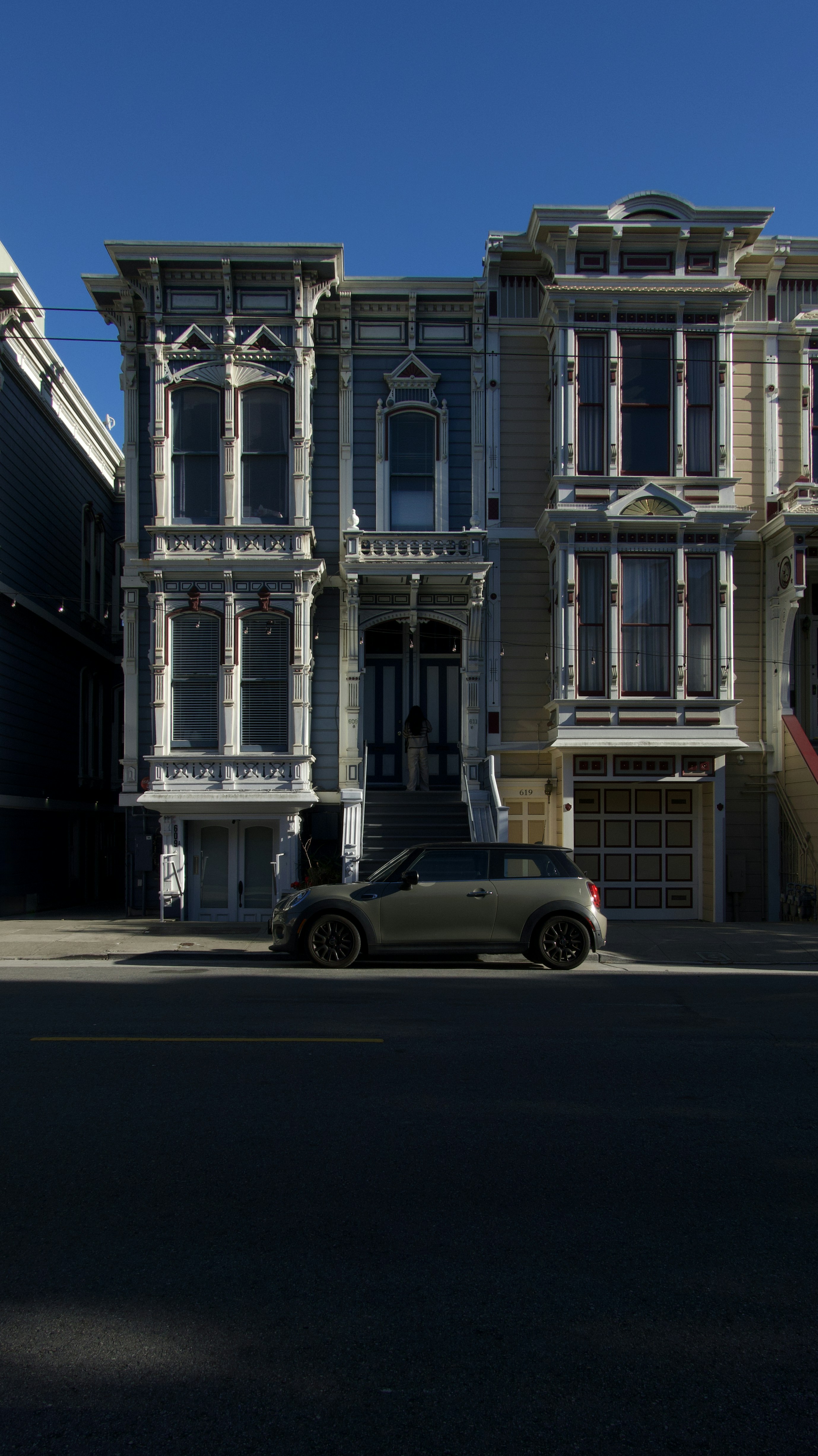 Sunlit Victorian Facades Meet a Silver Compact on a Quiet Street