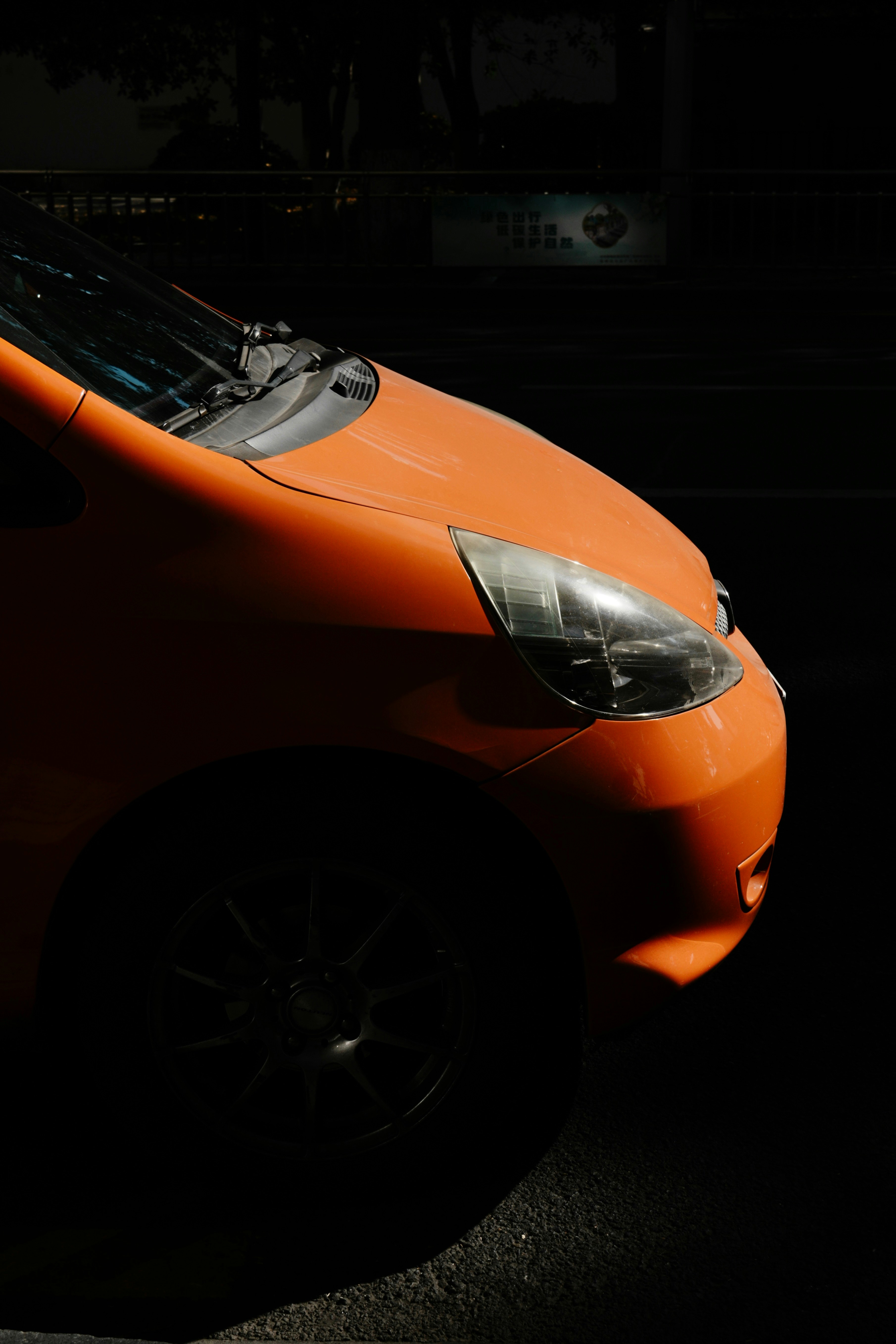 A small orange car parked in a parking lot photo – Free Car Image on ...