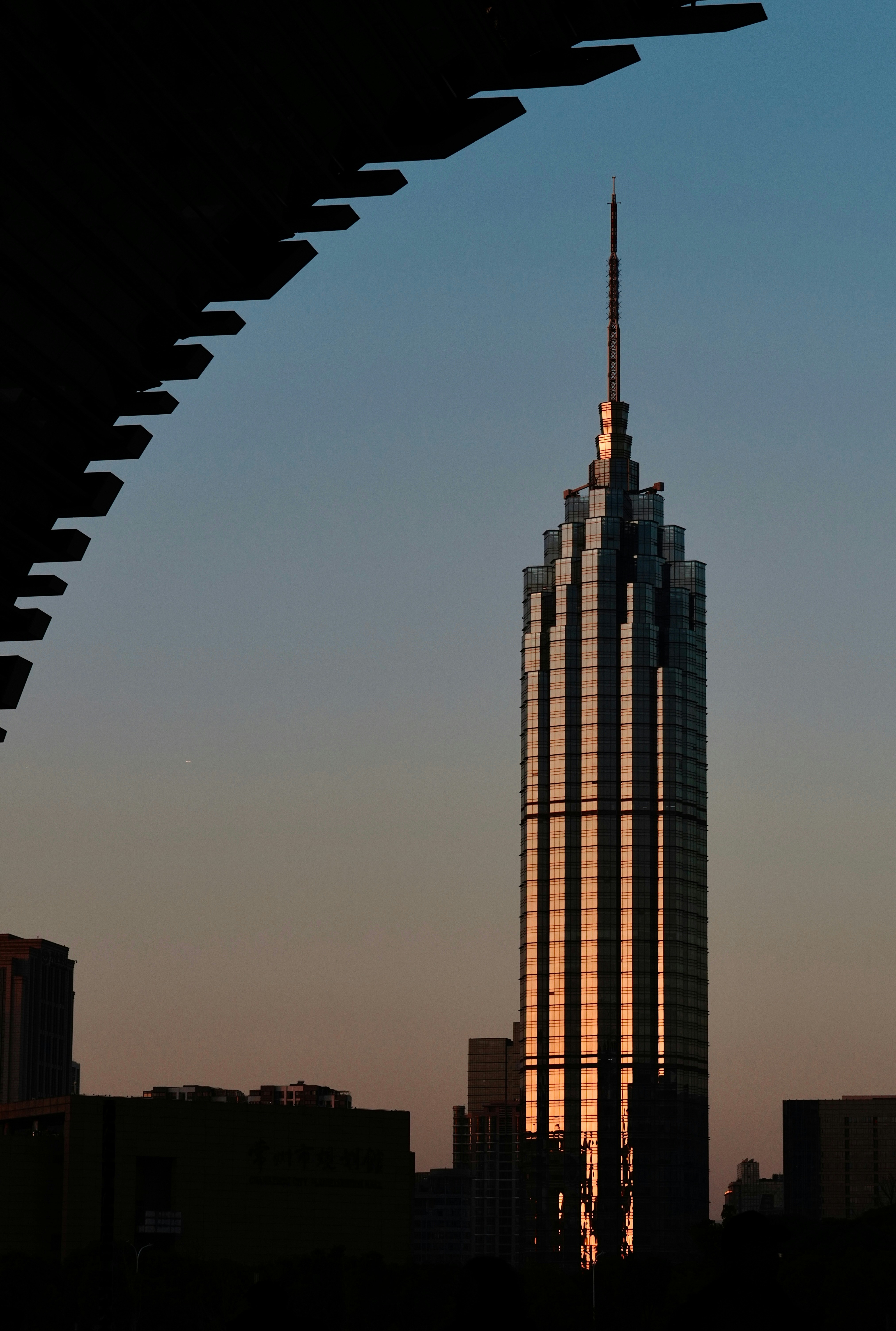 A very tall building towering over a city photo – Free 常州市 Image on ...